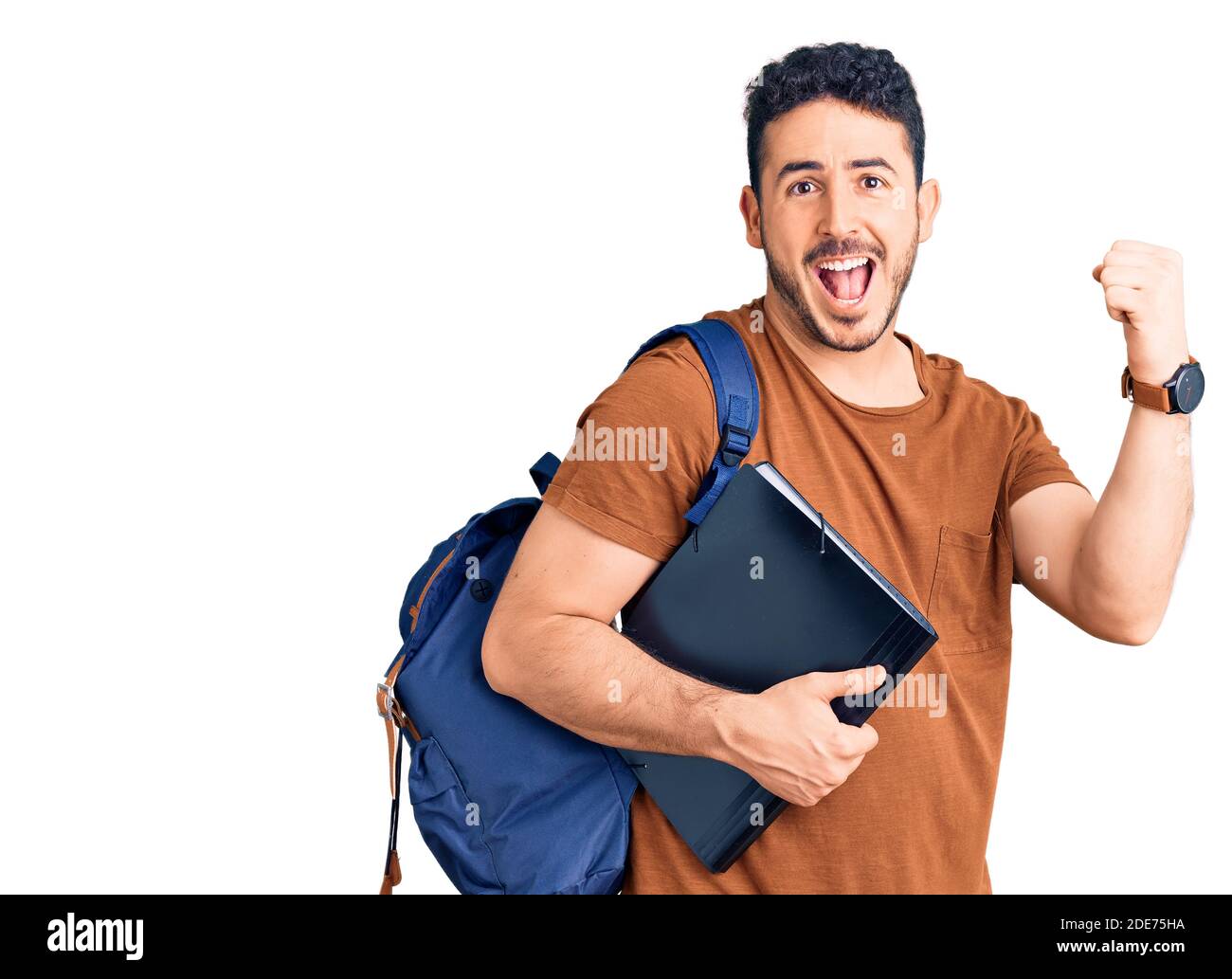 Young hispanic man wearing student backpack holding binder screaming ...