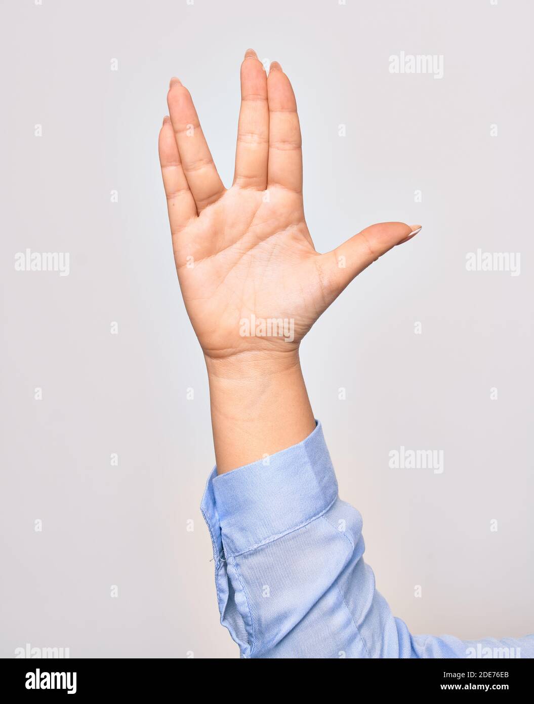 Hand of caucasian young woman doing freaky star trek salutation over ...