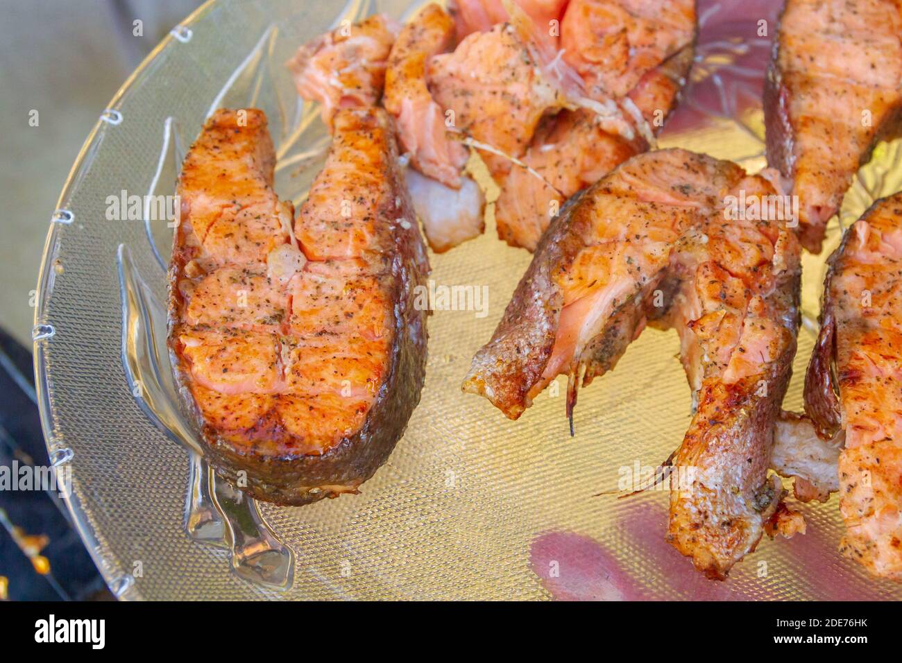 Grilled red fish trout steaks lie on a glass plate Stock Photo - Alamy