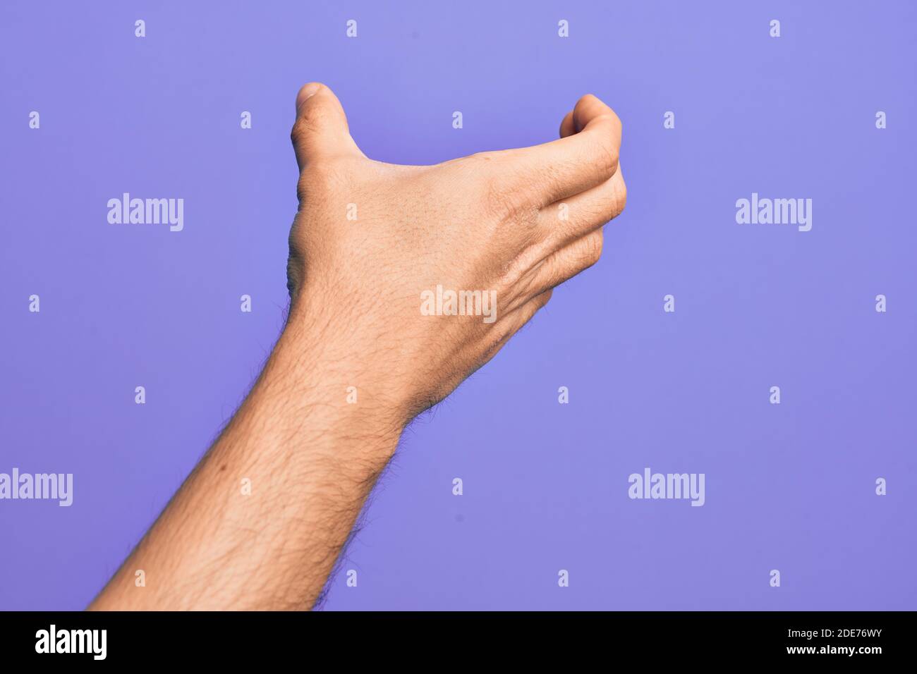 Hand of caucasian young man showing fingers over isolated purple ...
