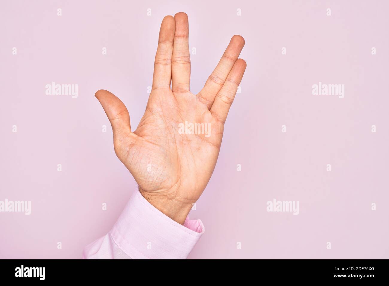 Hand of caucasian young man showing fingers over isolated pink ...