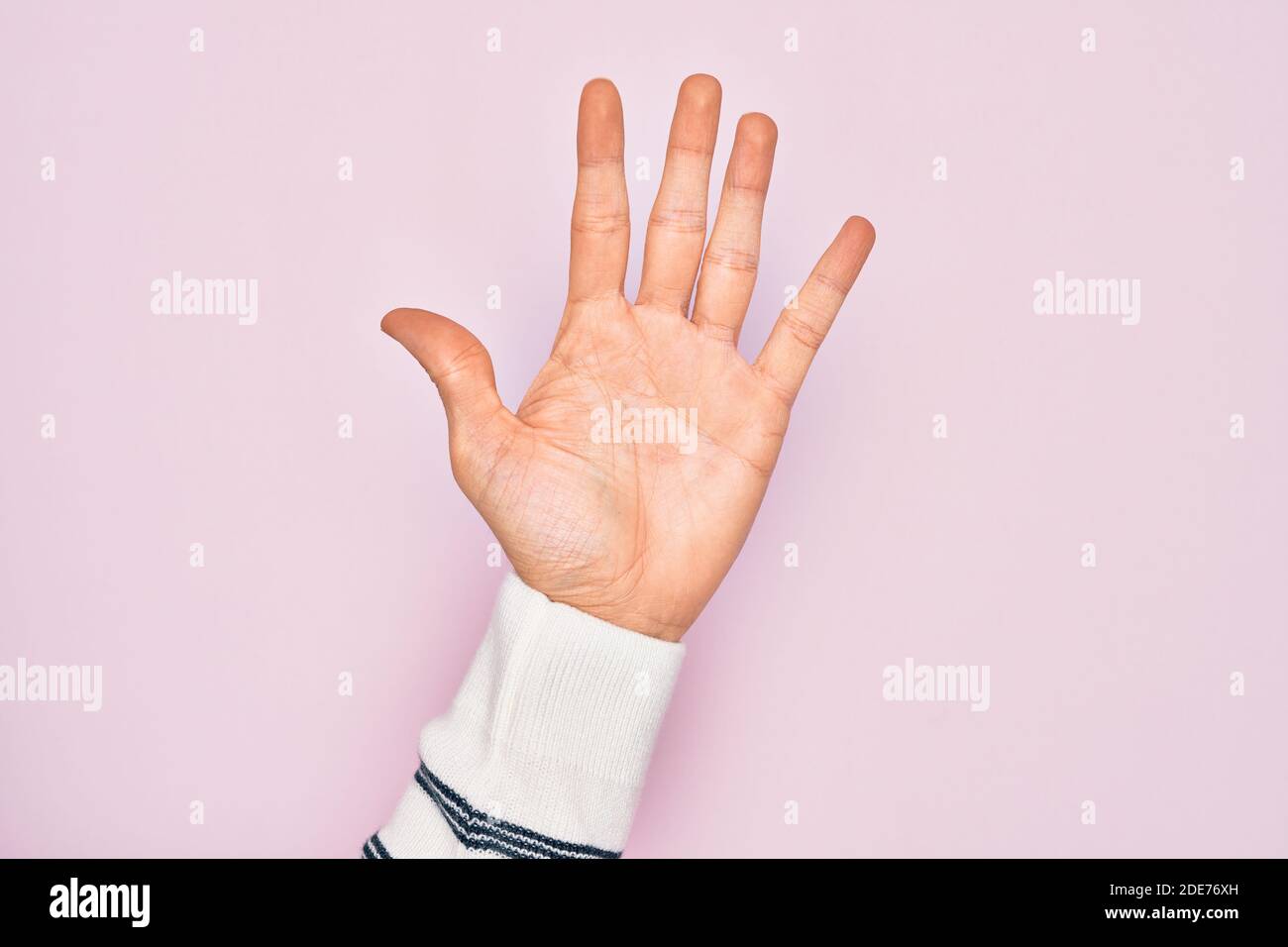 Hand of caucasian young man showing fingers over isolated pink ...