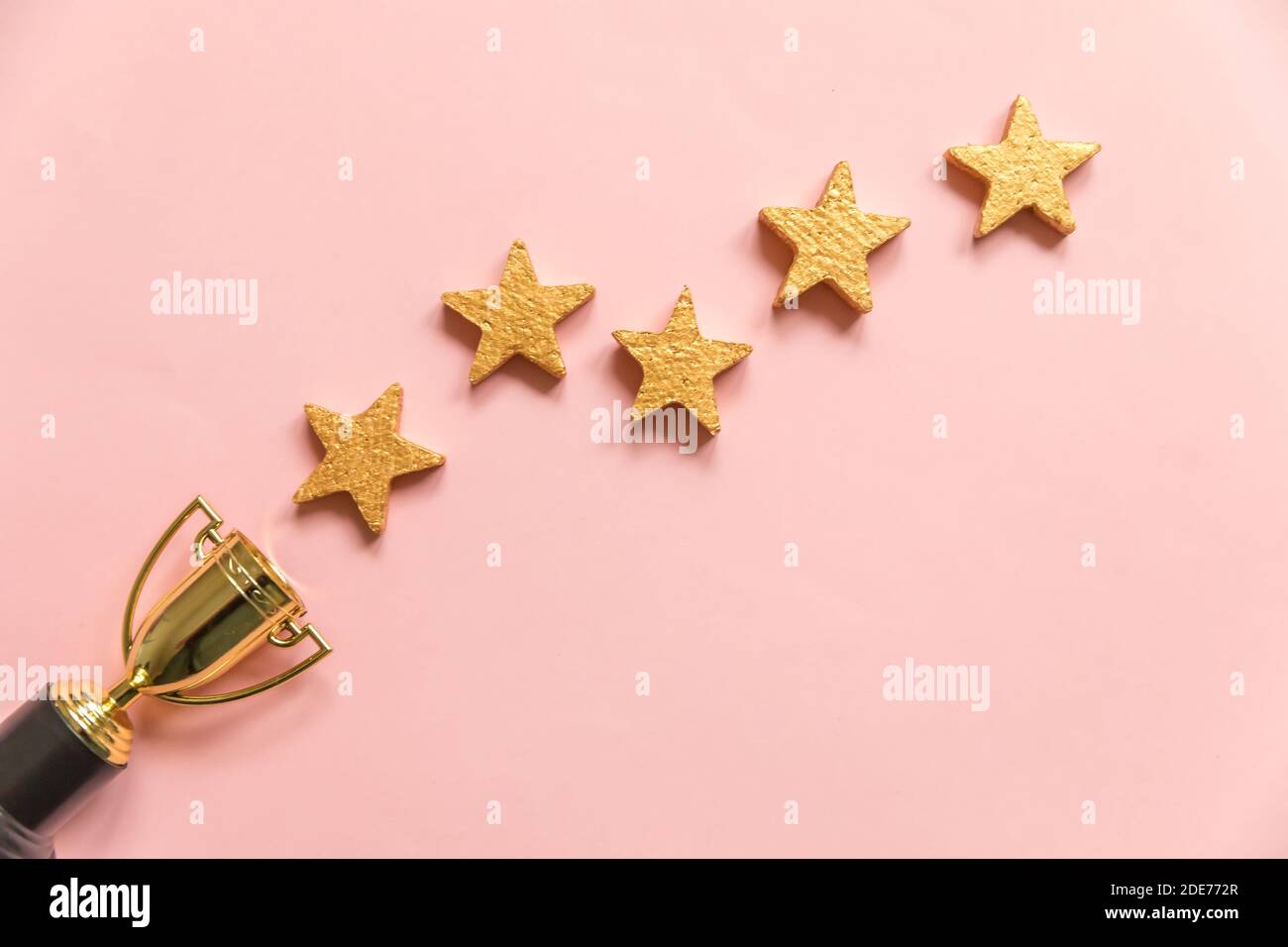 Simply flat lay design winner or champion gold trophy cup and 5 stars ...