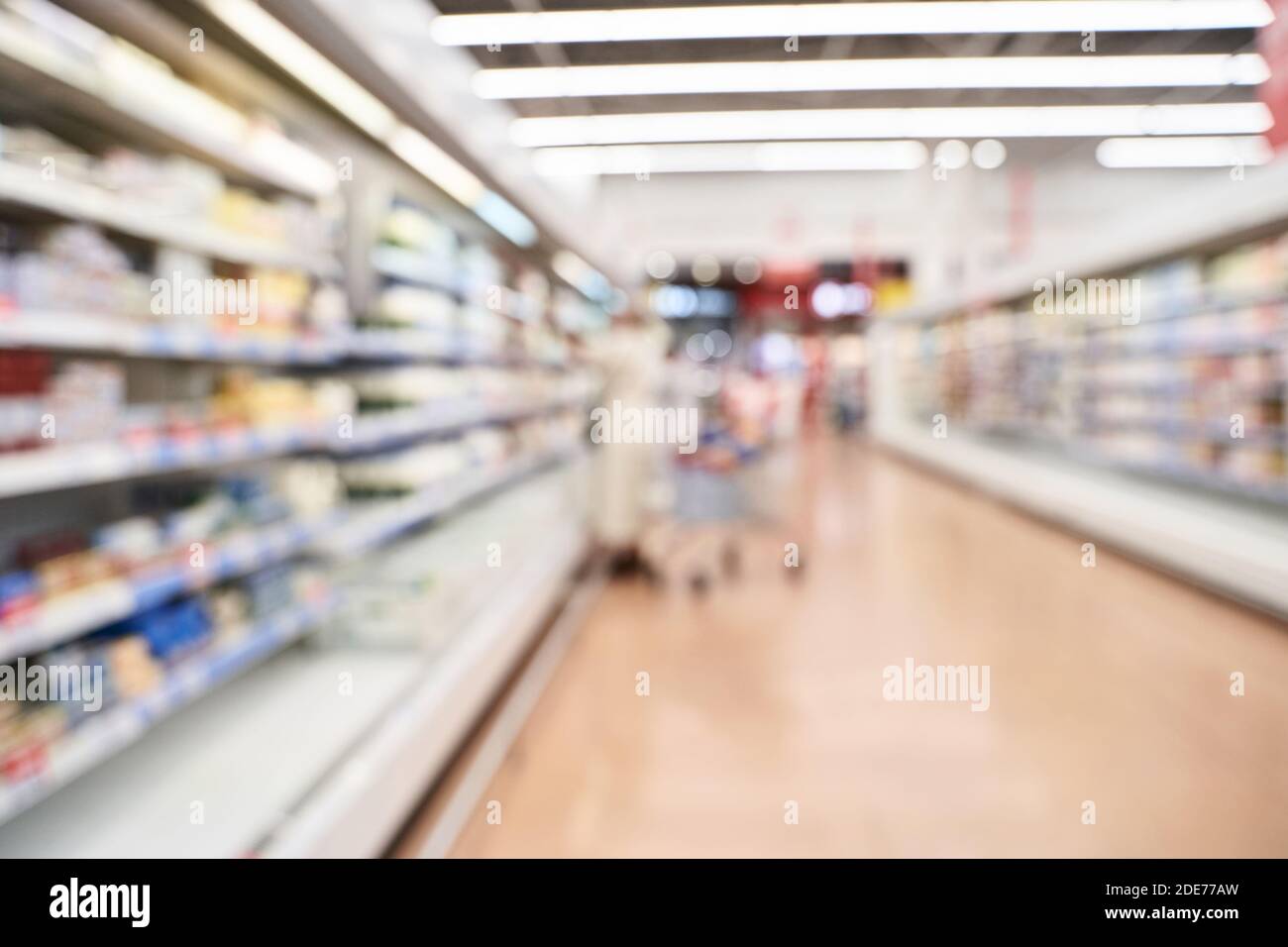 Food market interior. Blur corridor background. Shop shelf. Stock goods ...