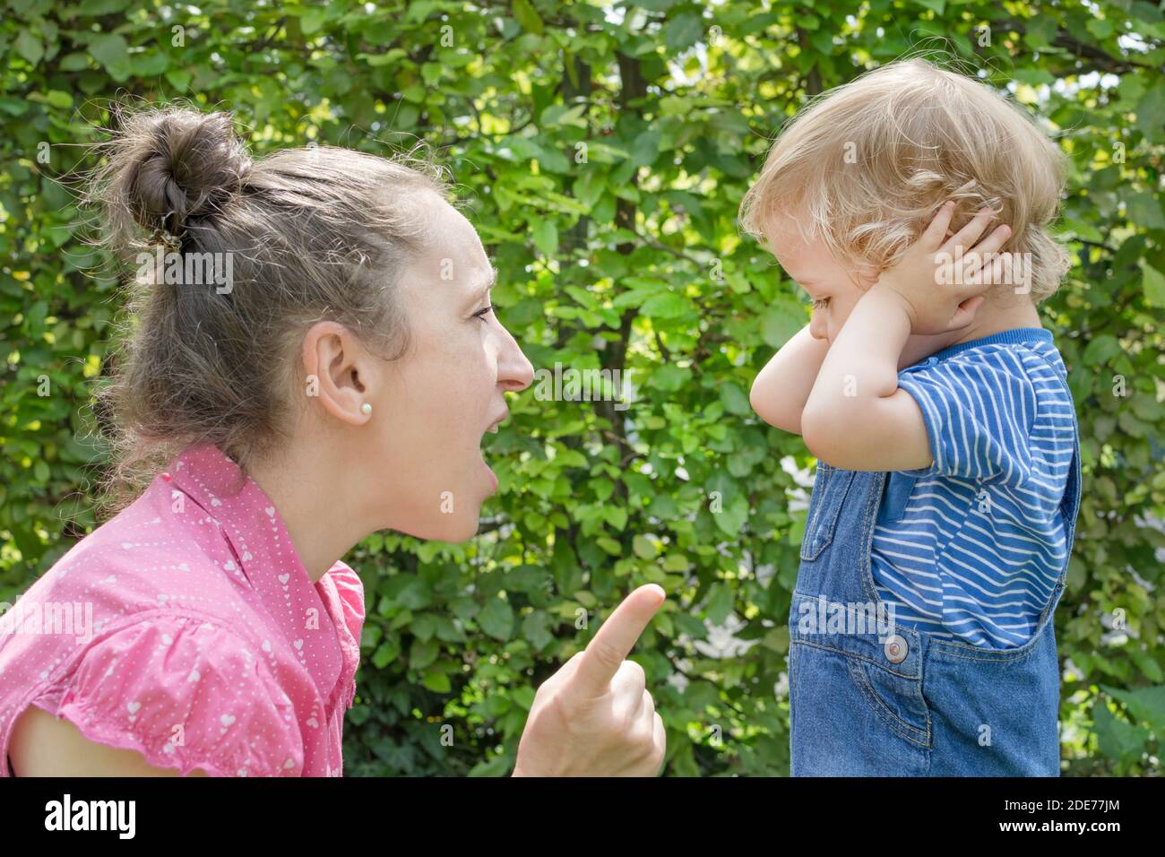 Angry mother shout at her naughty son in the park.the little child ...