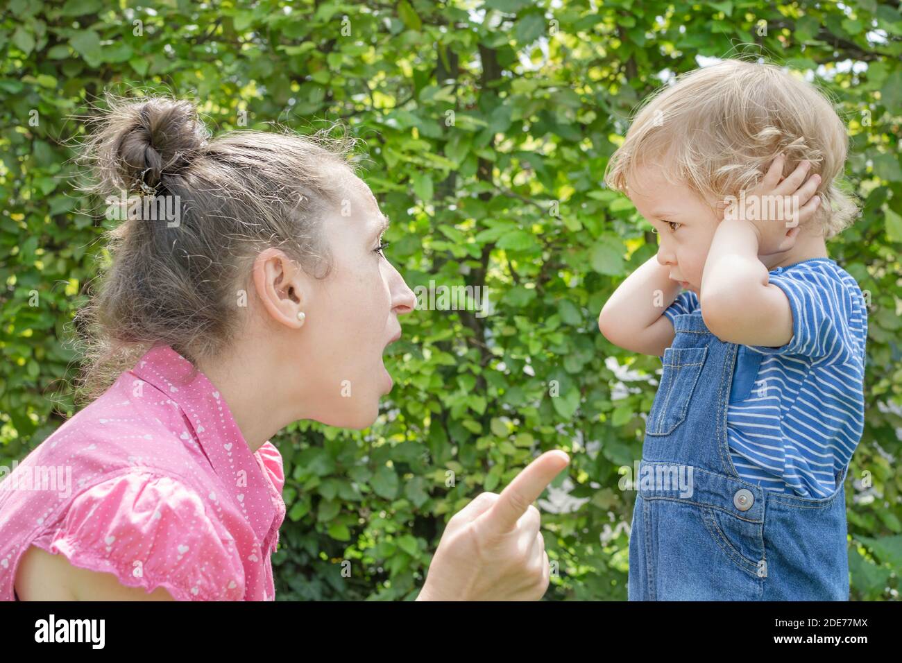 Angry mother shout at her naughty son in the park.the little child ...