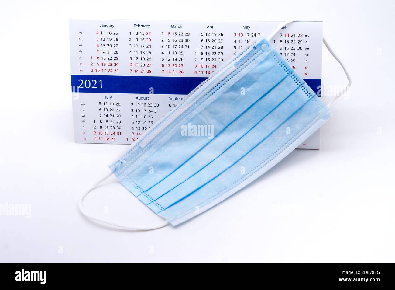 blue disposable mask on the calendar, medical face mask and calendar ...