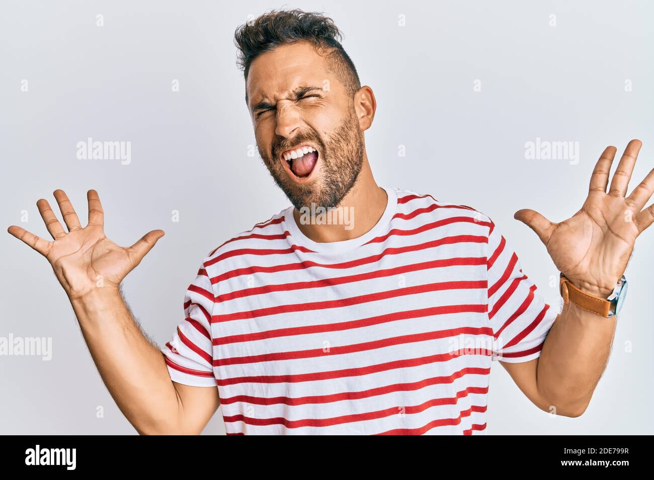 Handsome man with beard wearing casual clothes celebrating mad and ...