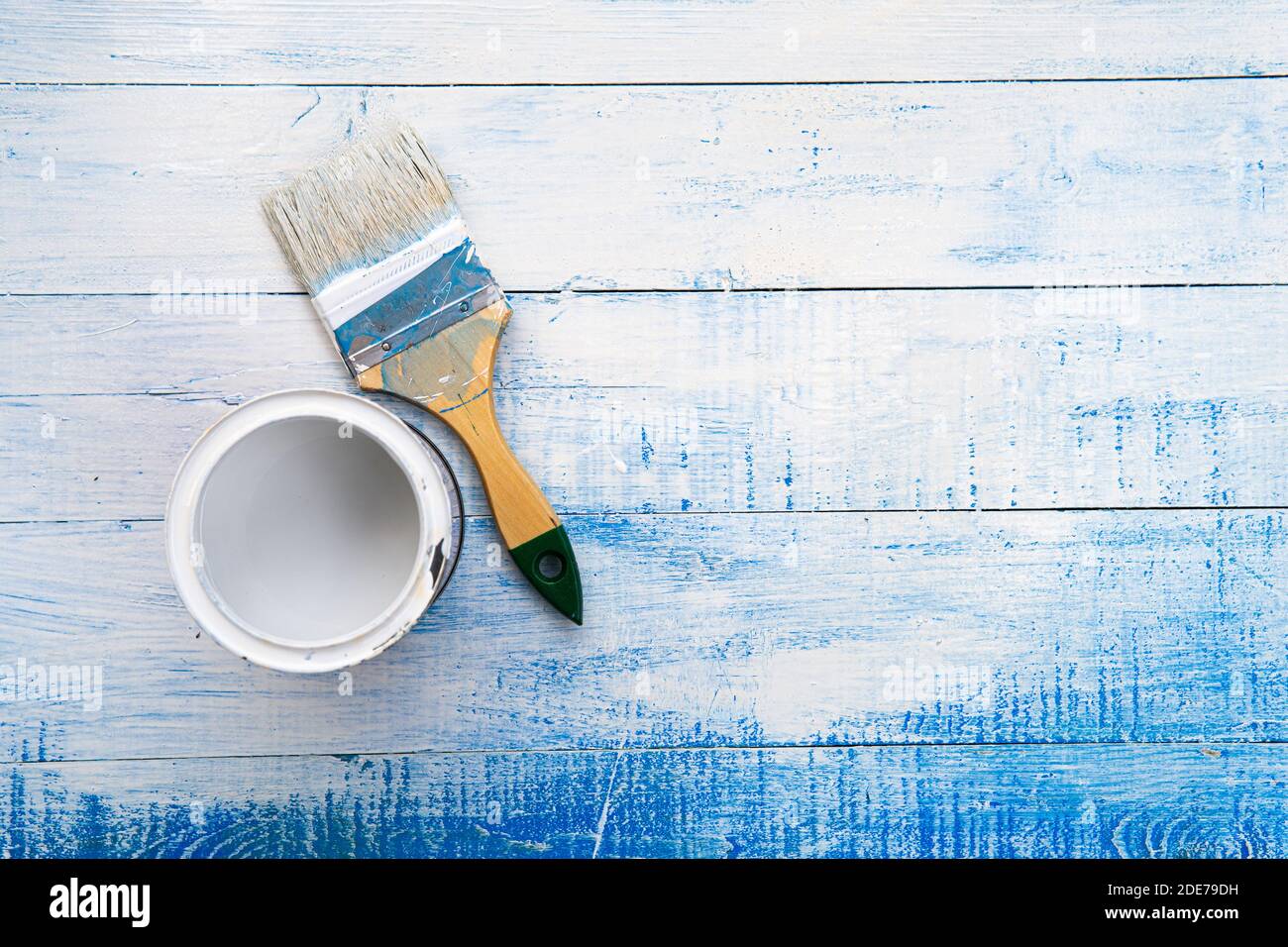 Painting works background with a paint brush with a can of a white ...