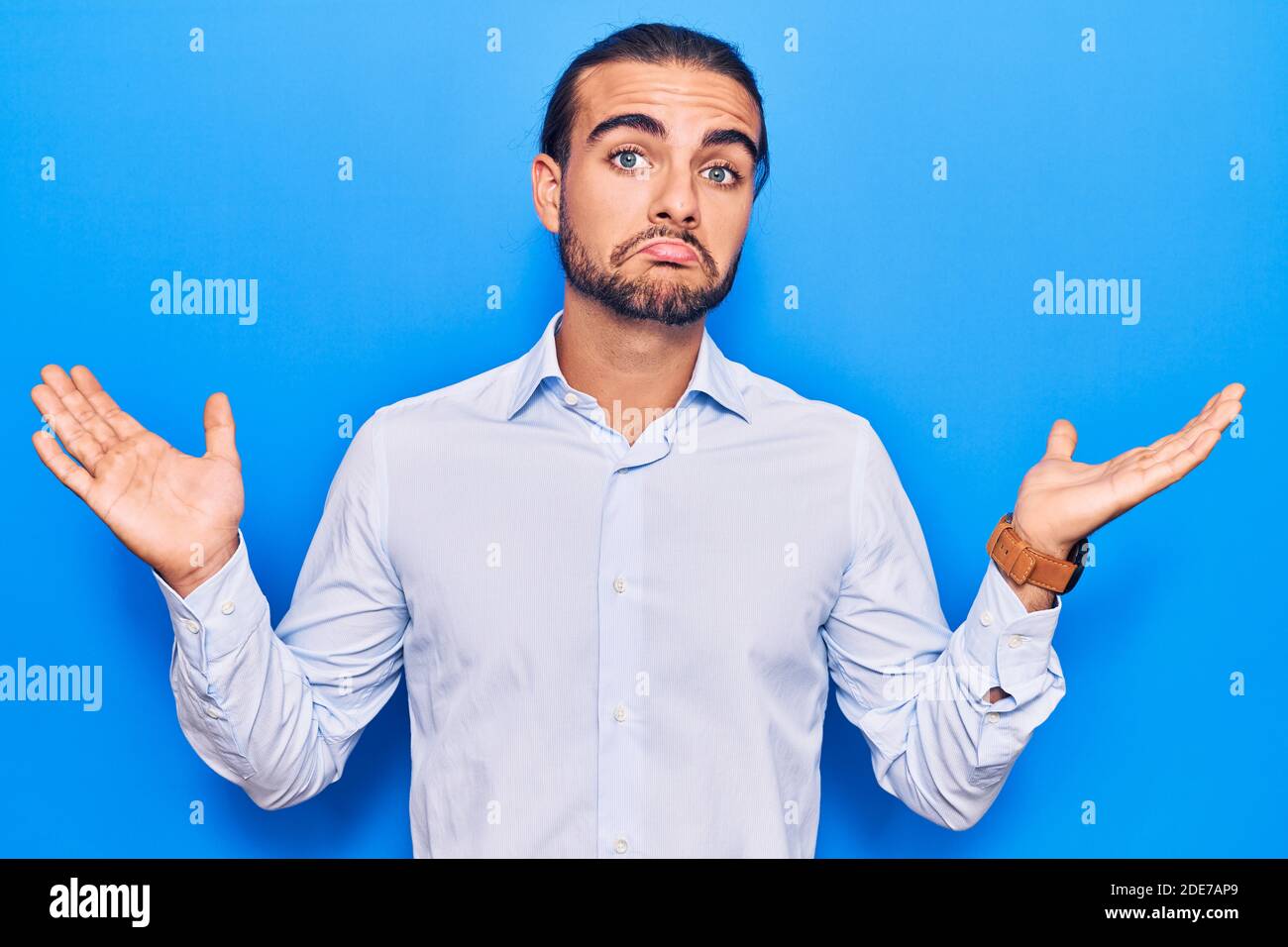 Young handsome man wearing business clothes clueless and confused with ...