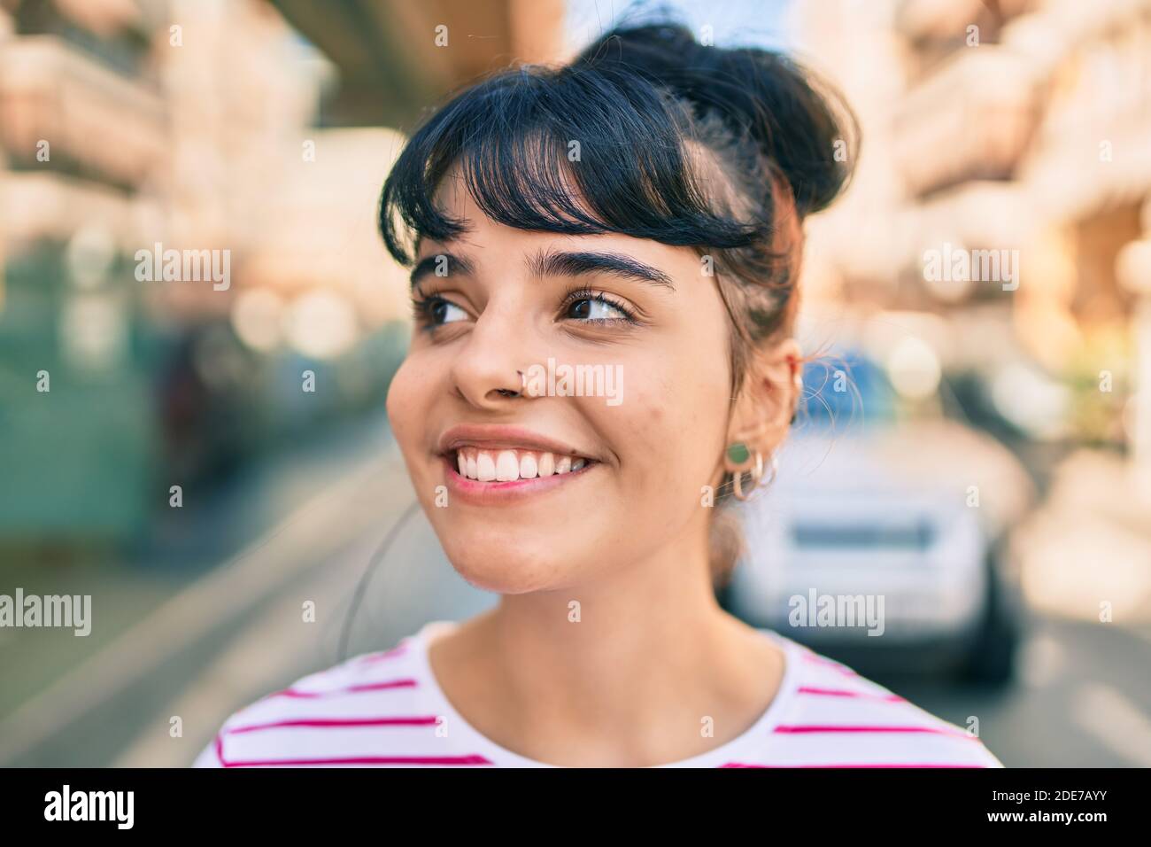 Young hispanic girl smiling happy walking at the city Stock Photo - Alamy