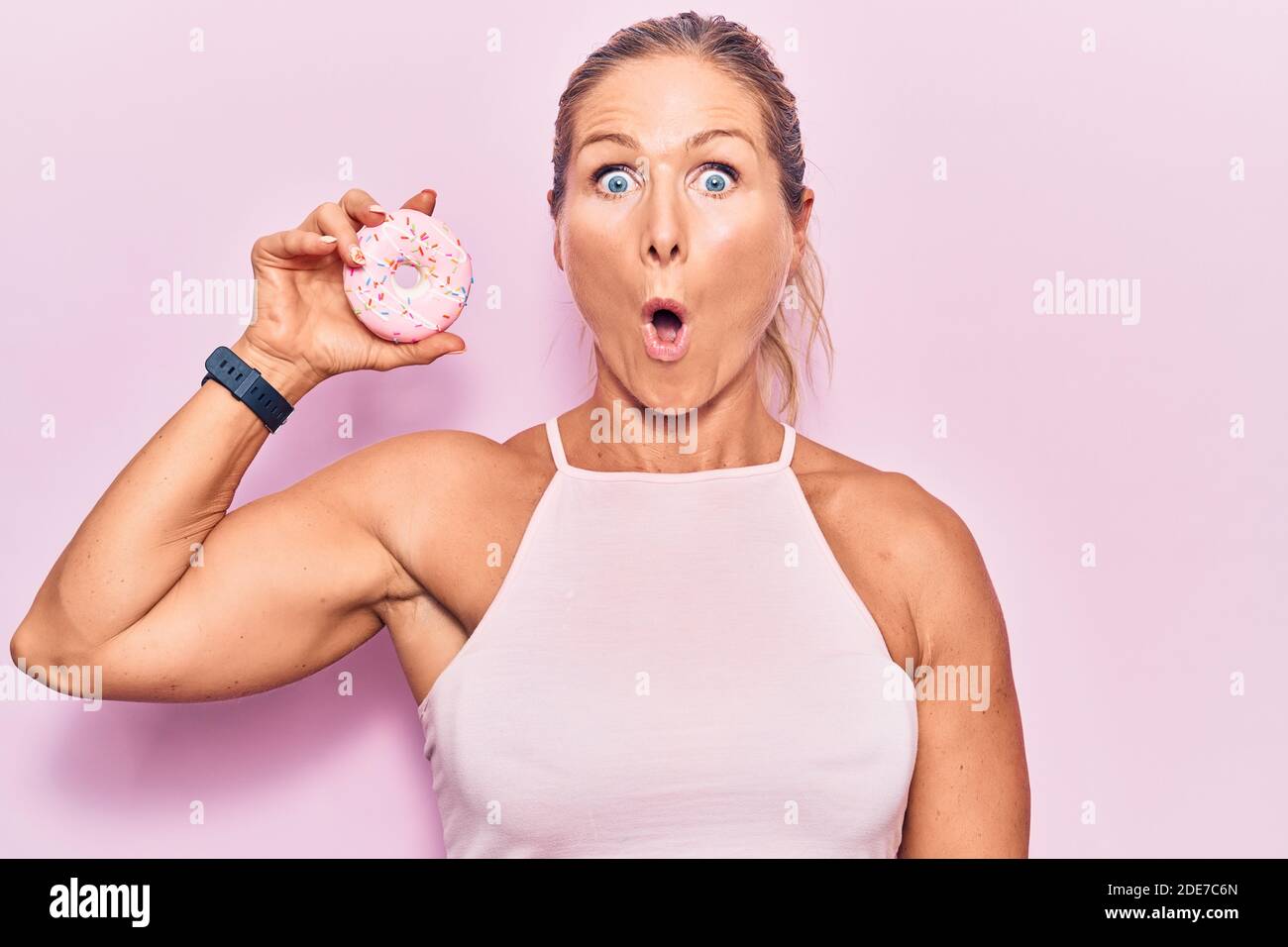 Middle age caucasian blonde woman wearing sporty clothes and holding ...