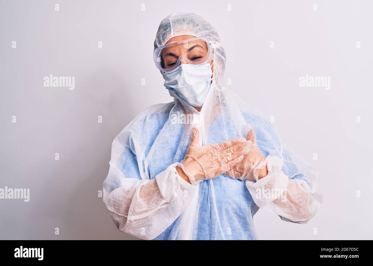 Middle age nurse woman wearing protection coronavirus equipment over ...