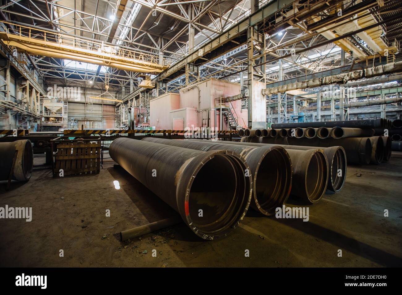 New cast iron pipes for pipeline construction in warehouse Stock Photo ...