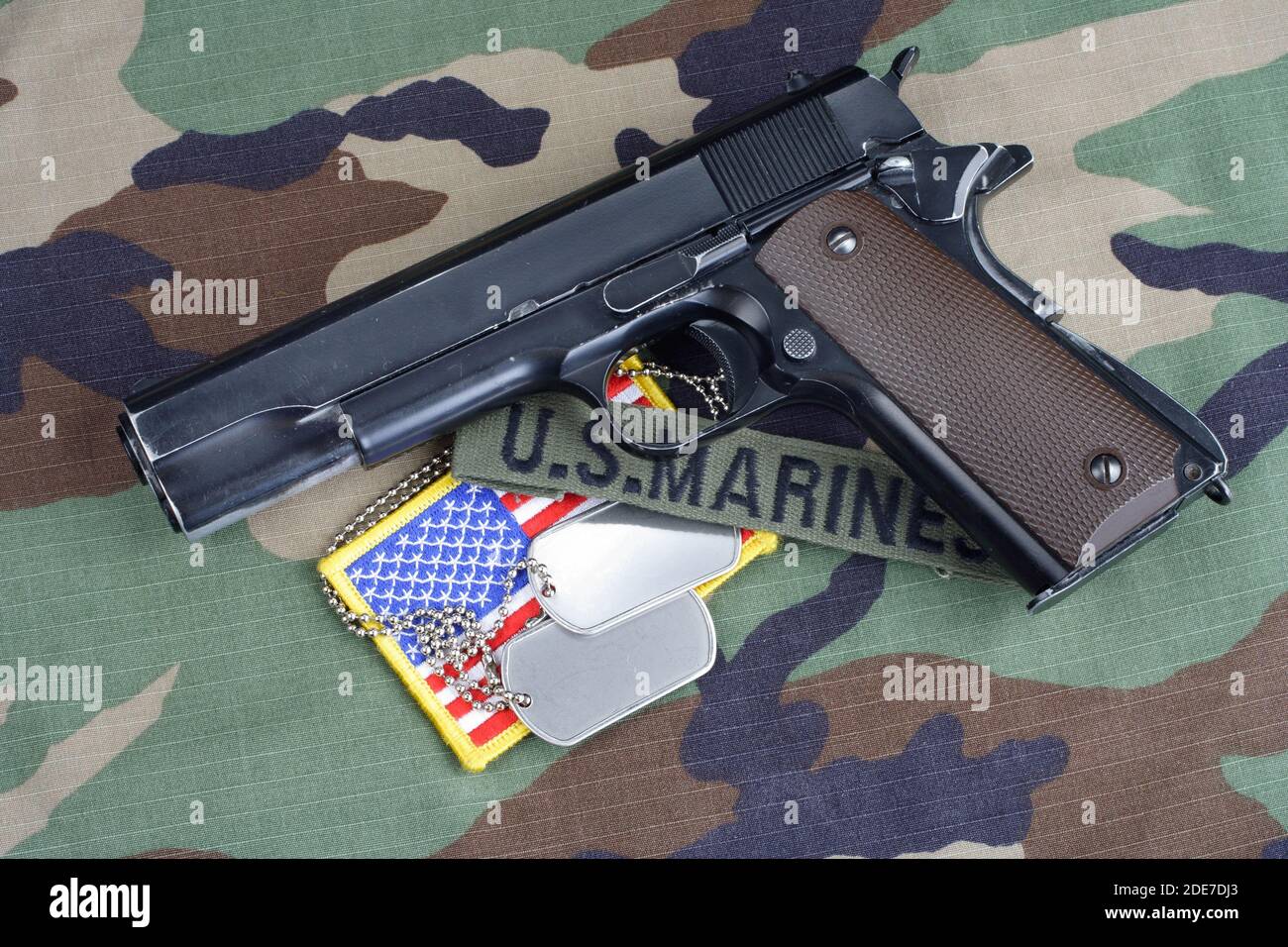 US MARINES branch tape, M1911 handgun with dog tags on woodland ...