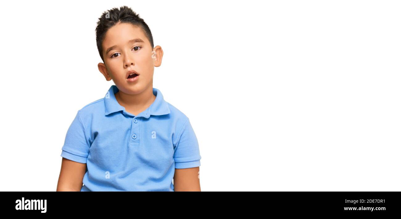 Little boy hispanic kid wearing casual clothes in shock face, looking ...