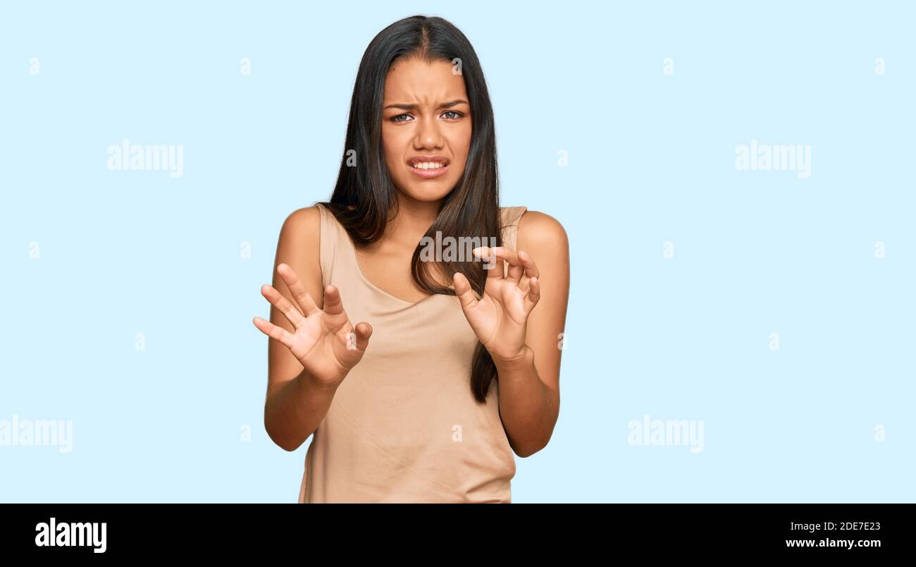 Beautiful hispanic woman wearing casual clothes disgusted expression ...