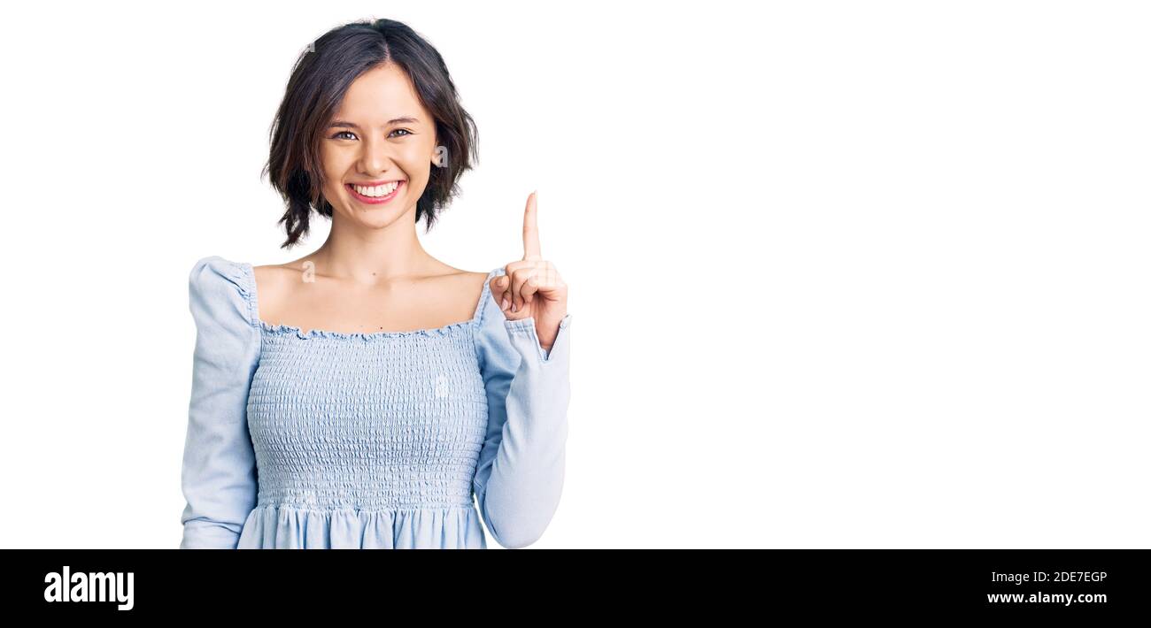 Young beautiful girl wearing casual clothes showing and pointing up ...