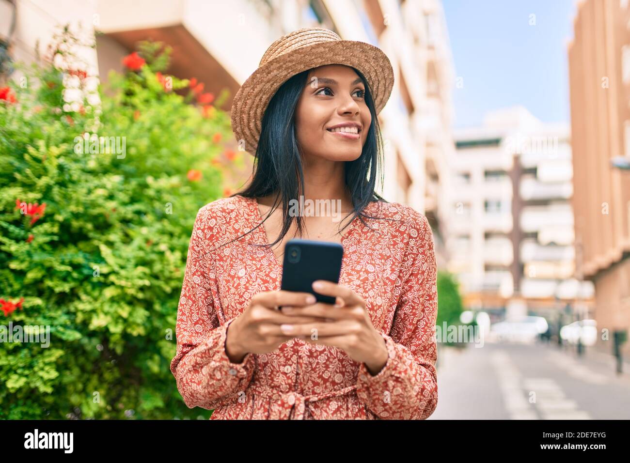 Young african american tourist woman on vacation smiling happy using ...