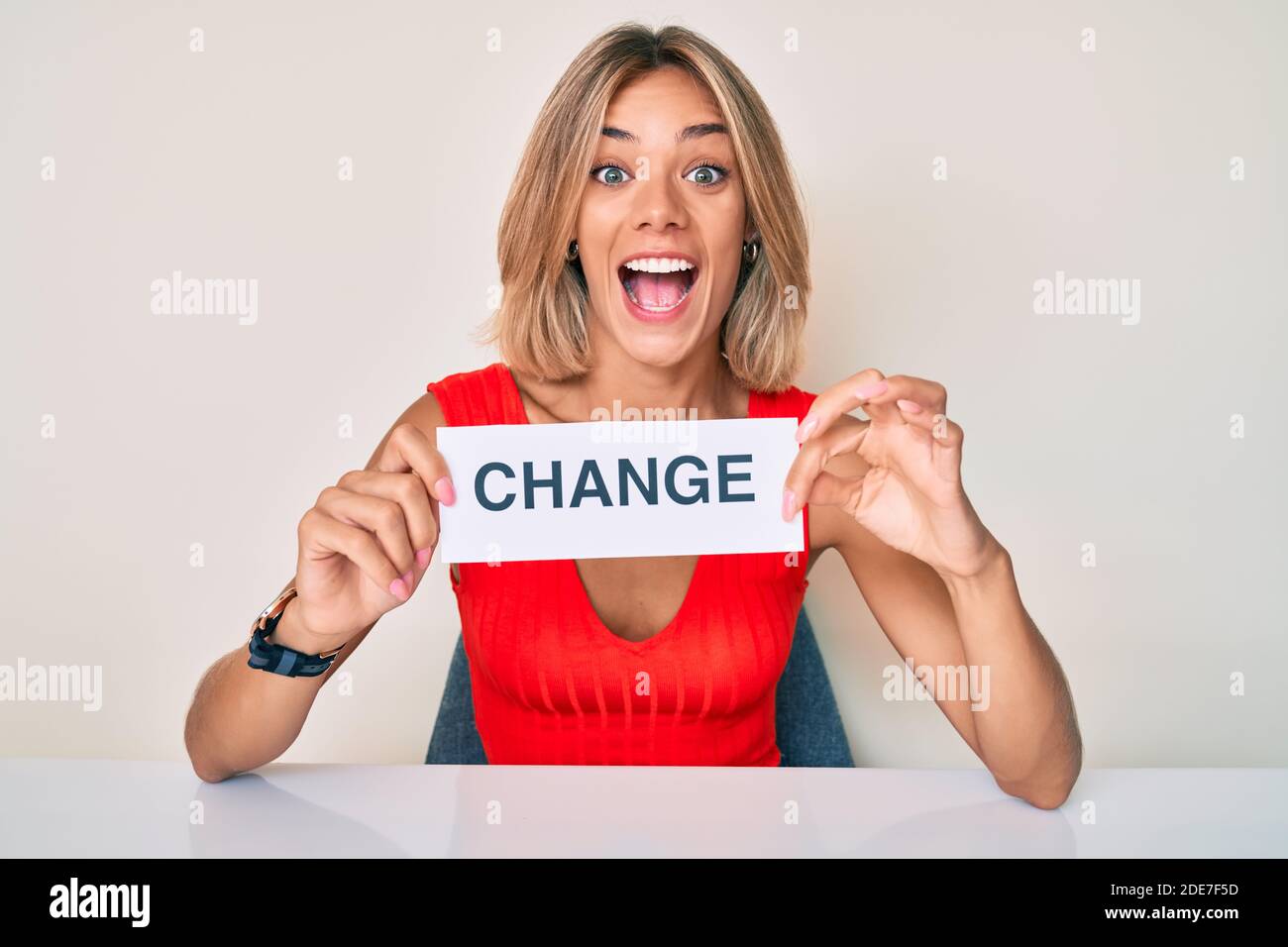 Beautiful caucasian woman holding change banner celebrating crazy and ...