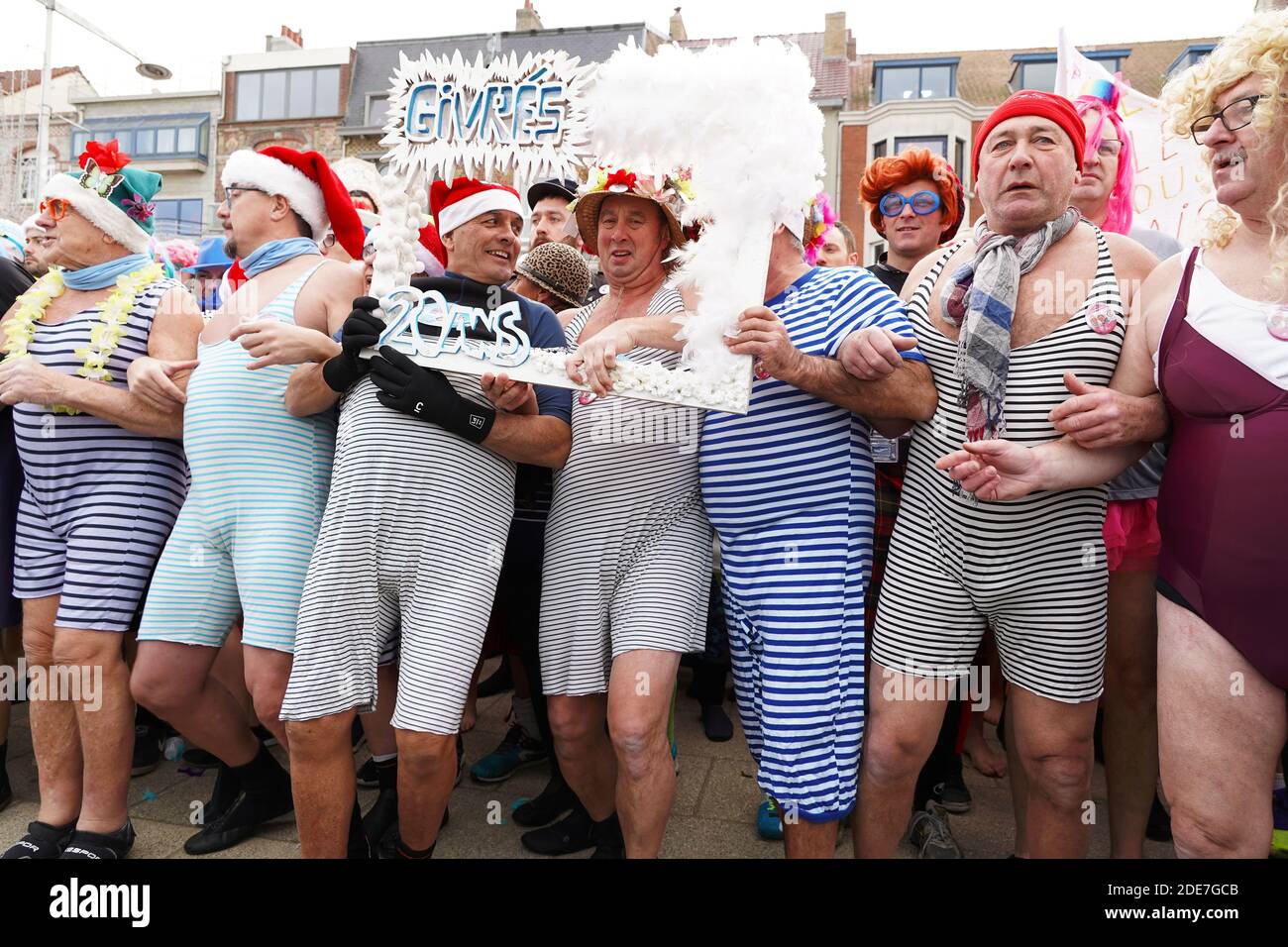 Revellers take part in the traditional "Bain des Givres" as part of the ...