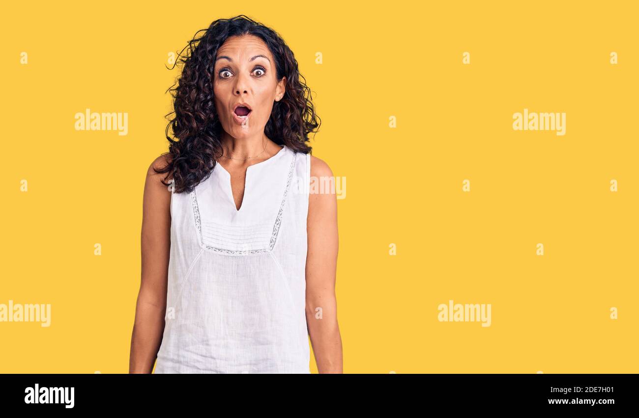 Middle age beautiful woman wearing casual sleeveless t shirt scared and ...