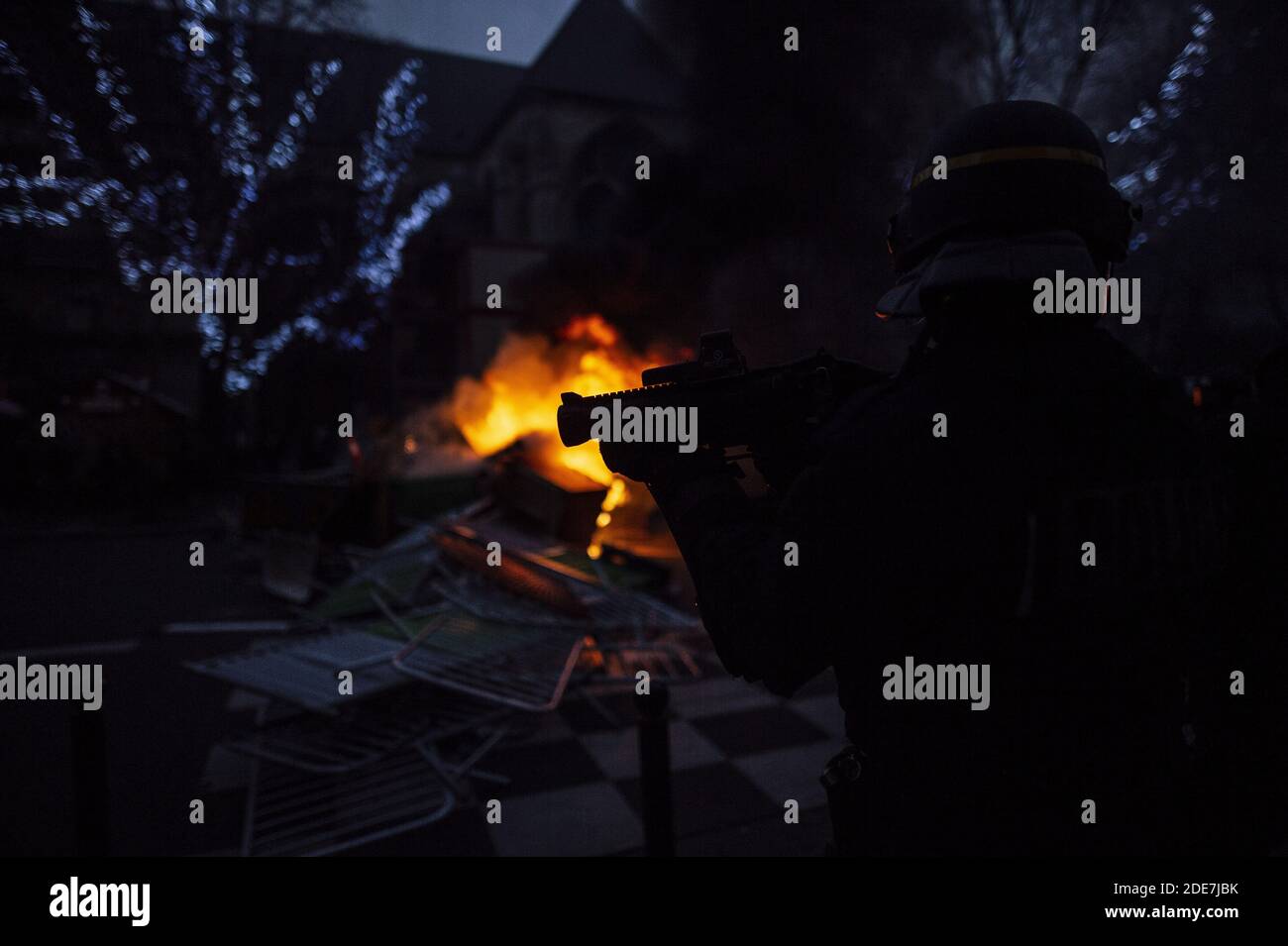 French policeman points a flash-ball gun a demonstration by the "yellow ...