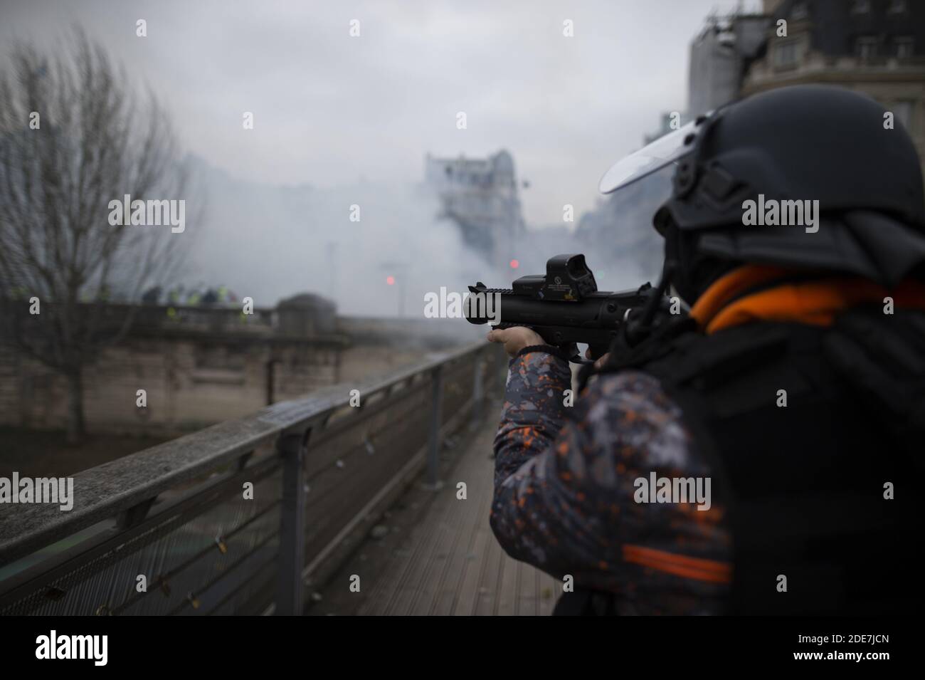 French policeman points a flash-ball gun a demonstration by the "yellow ...