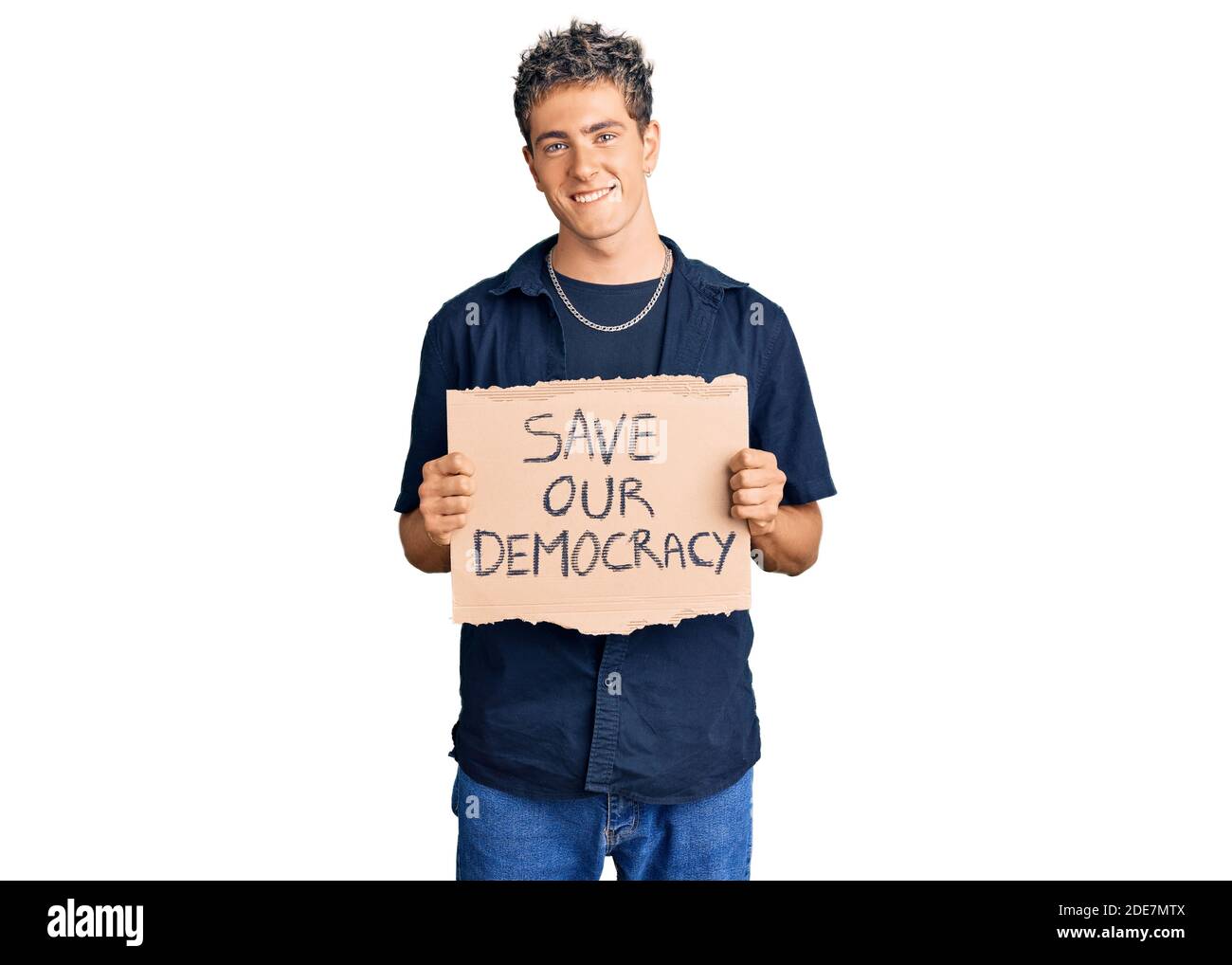 Young handsome man holding save our democracy protest banner looking ...