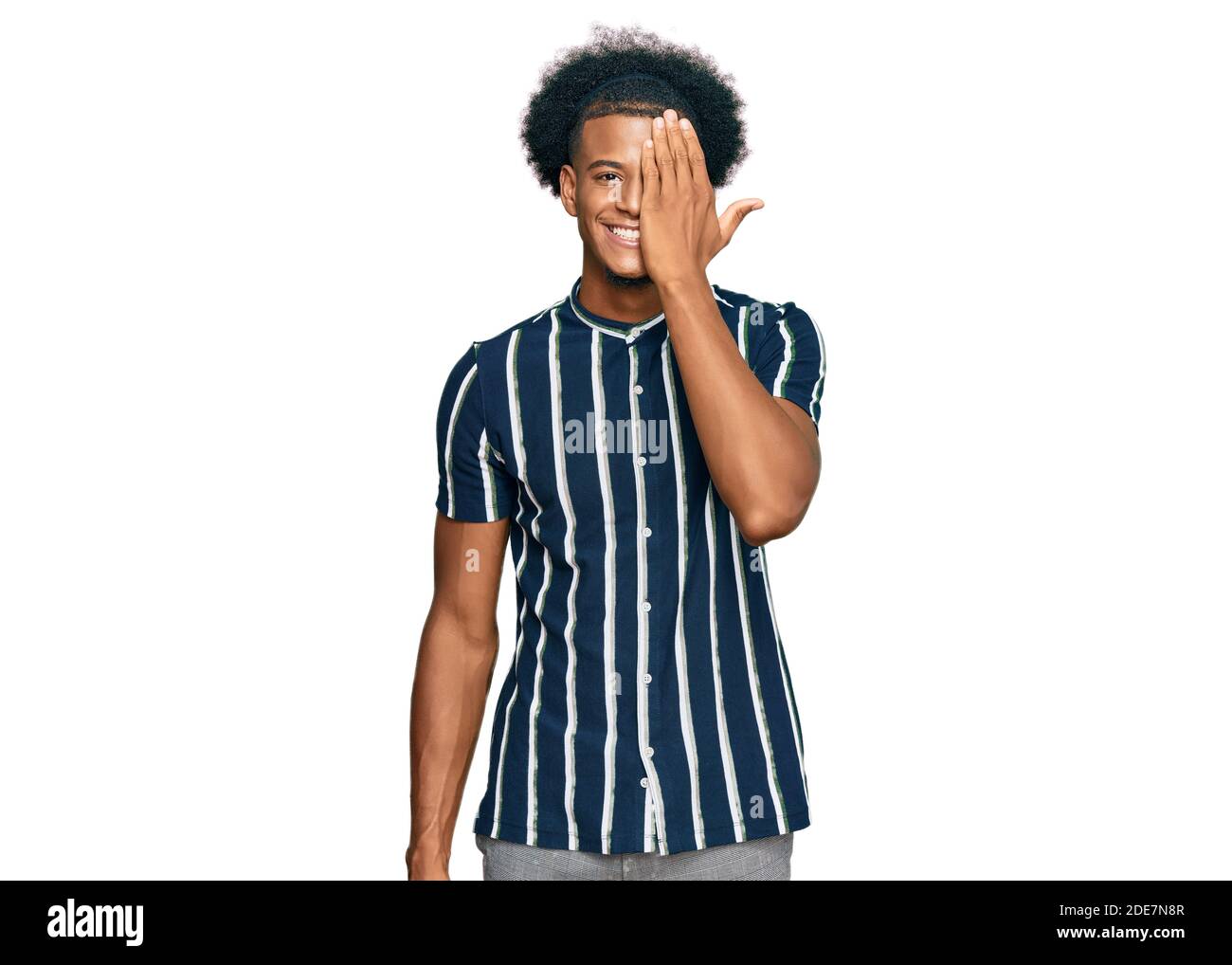 African american man with afro hair wearing casual clothes covering one ...