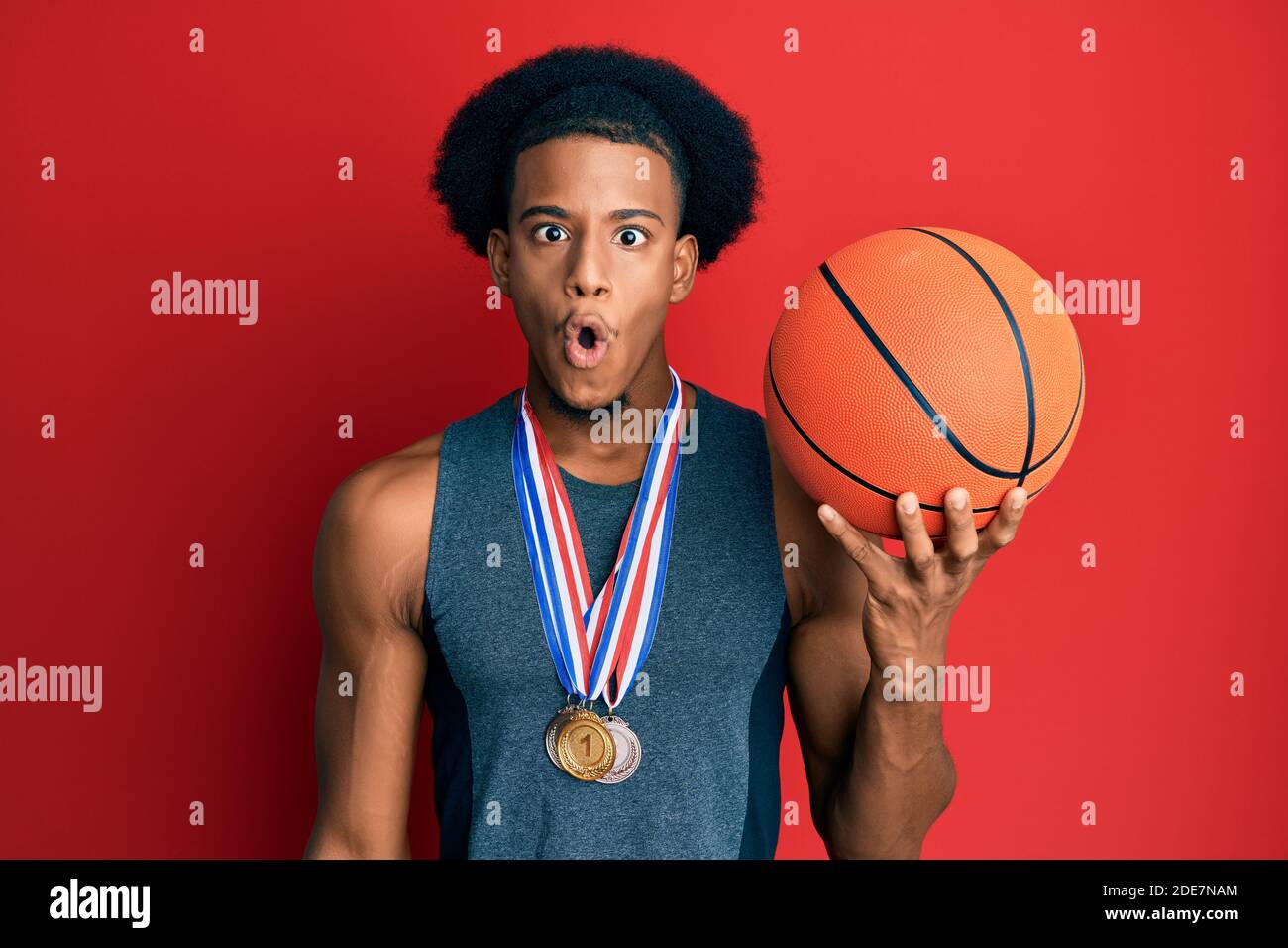 African american man with afro hair wearing winner medals at basketball ...