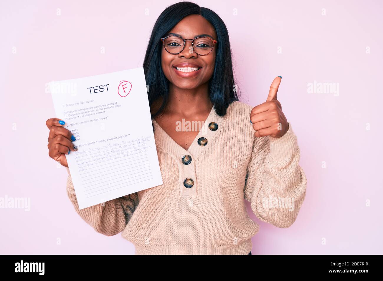 Young african american woman showing a failed exam smiling happy and ...