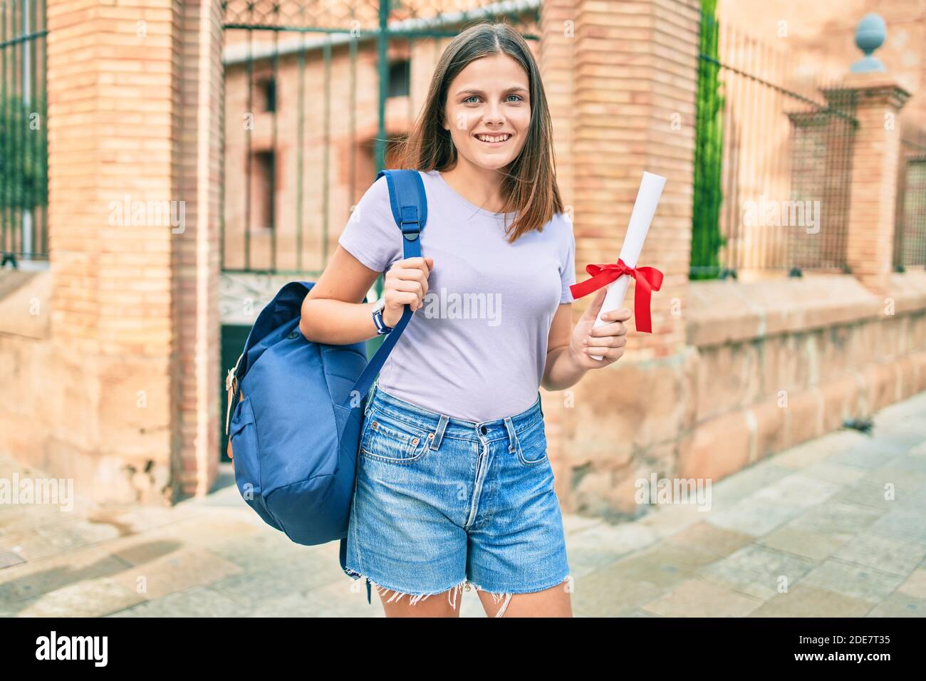 Young middle east student girl smiling happy holding diploma at the ...