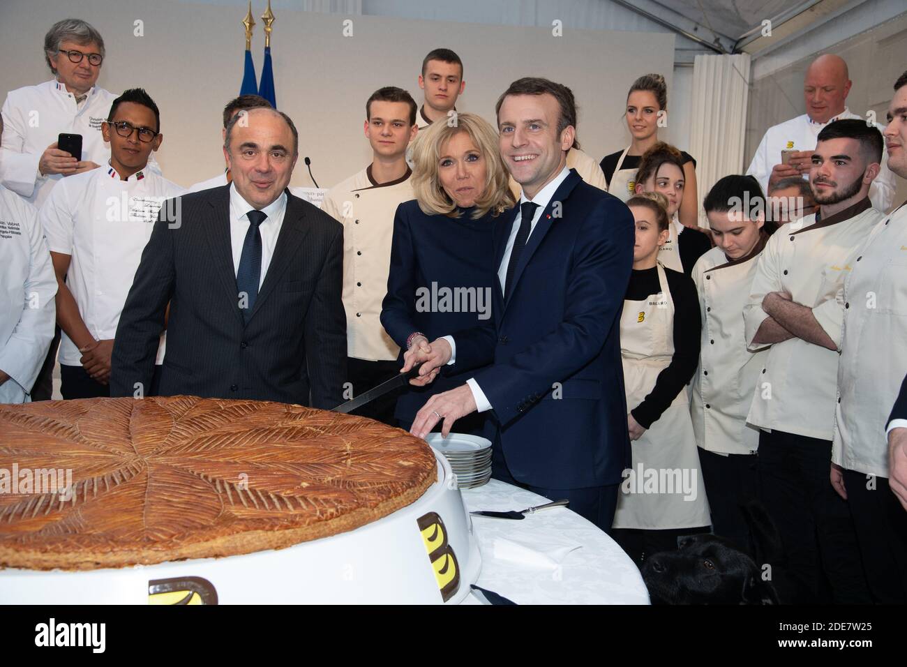 French President Emmanuel Macron and his wife Brigitte slice a ...