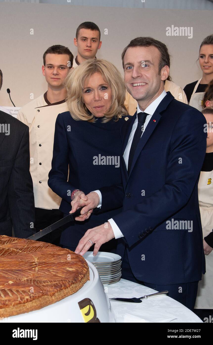 French President Emmanuel Macron and his wife Brigitte slice a ...