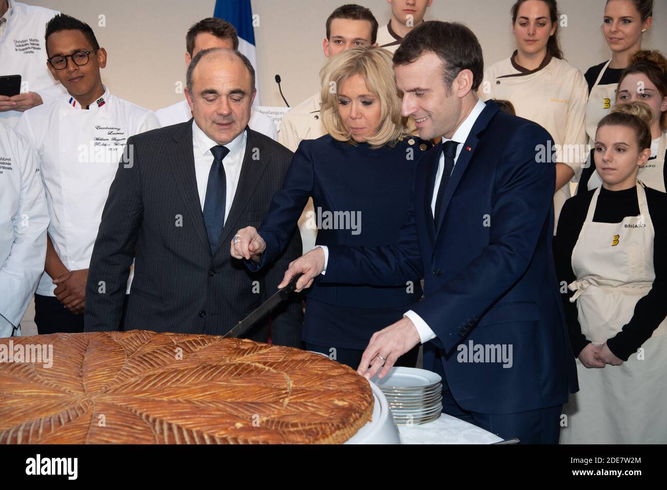French President Emmanuel Macron and his wife Brigitte slice a ...