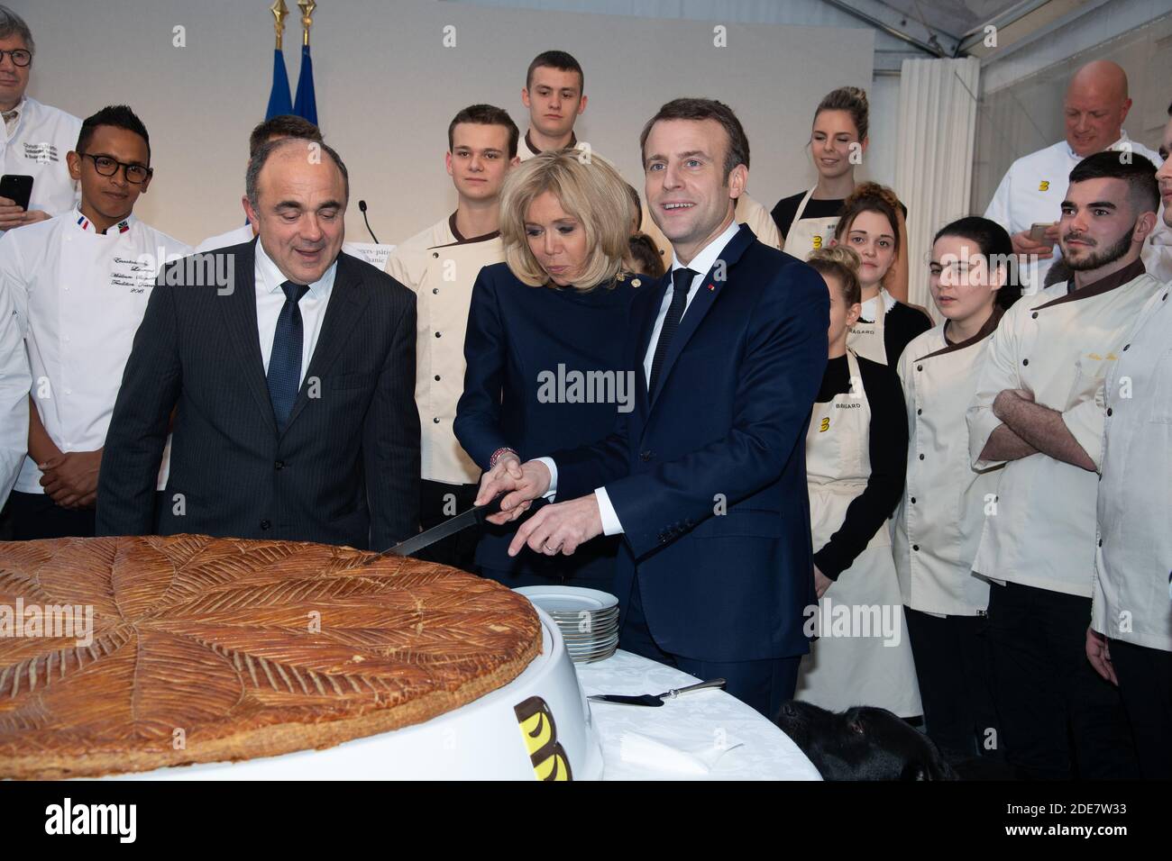 French President Emmanuel Macron and his wife Brigitte slice a ...