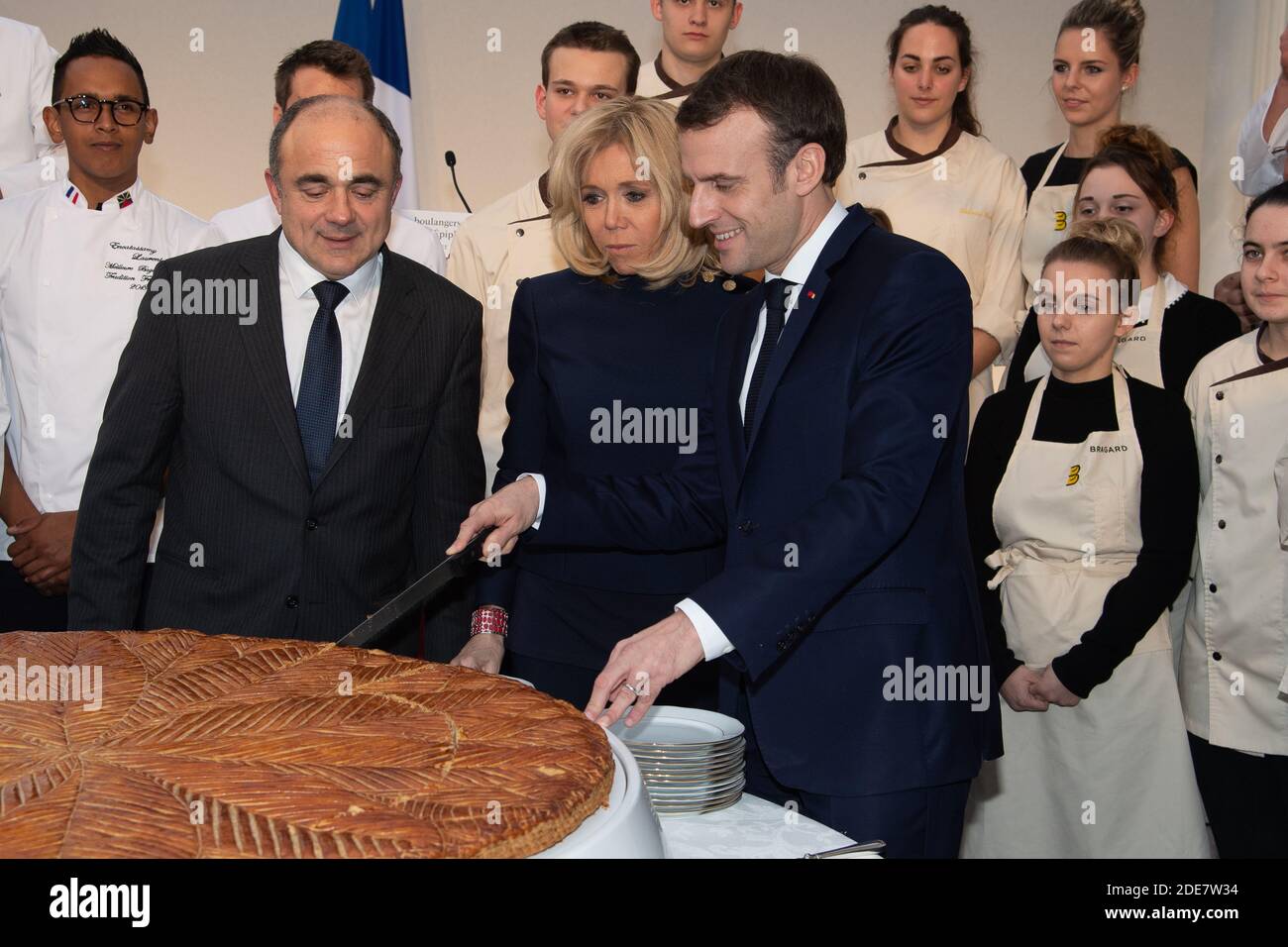 French President Emmanuel Macron and his wife Brigitte slice a ...
