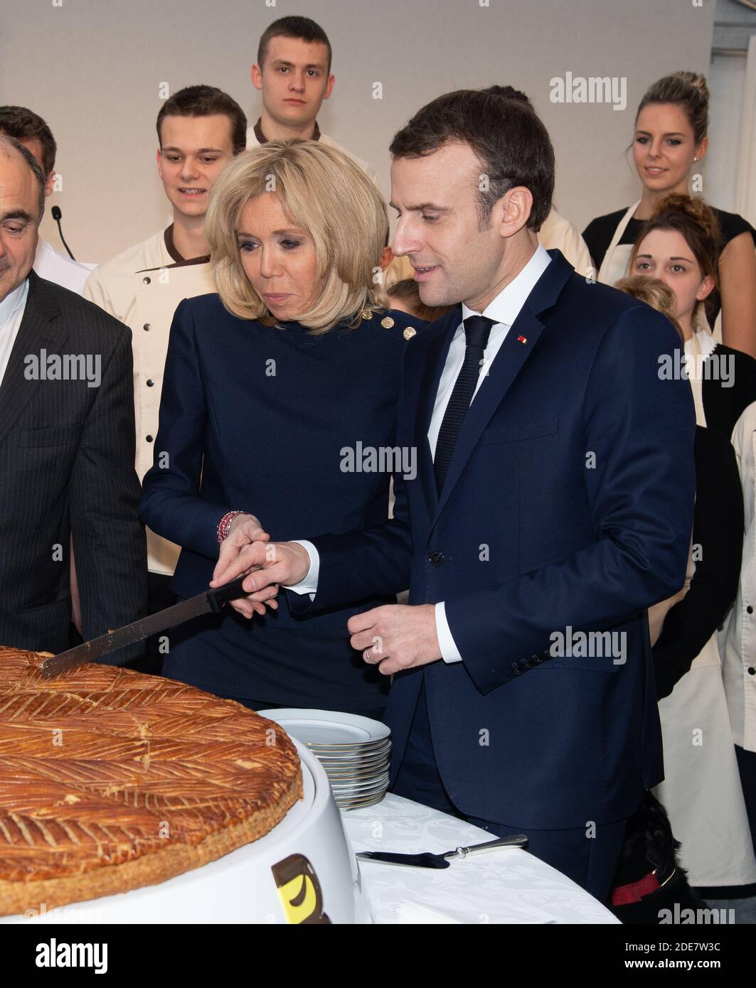 French President Emmanuel Macron and his wife Brigitte slice a ...