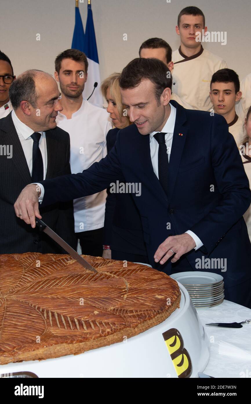 French President Emmanuel Macron and his wife Brigitte slice a ...