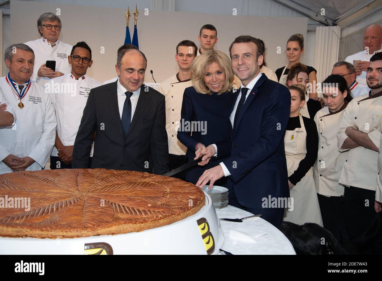 French President Emmanuel Macron and his wife Brigitte slice a ...