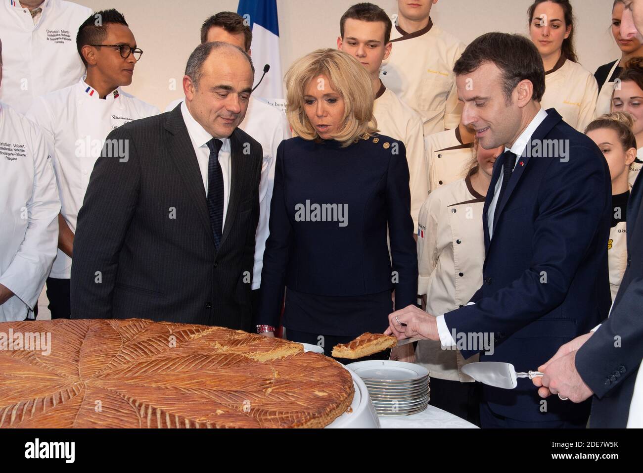 French President Emmanuel Macron and his wife Brigitte slice a ...