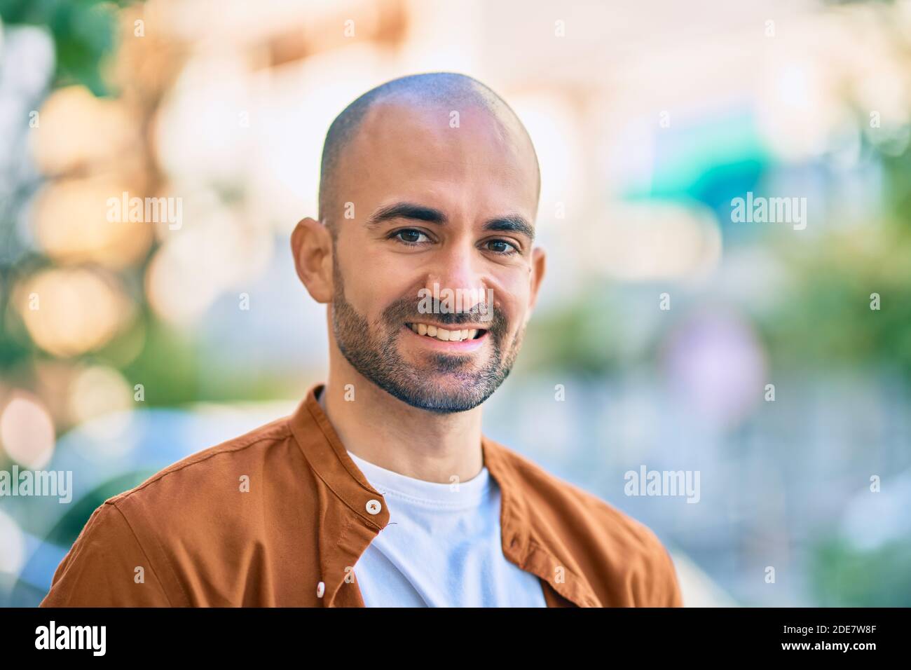 Young hispanic bald man smiling happy standing at the city Stock Photo ...