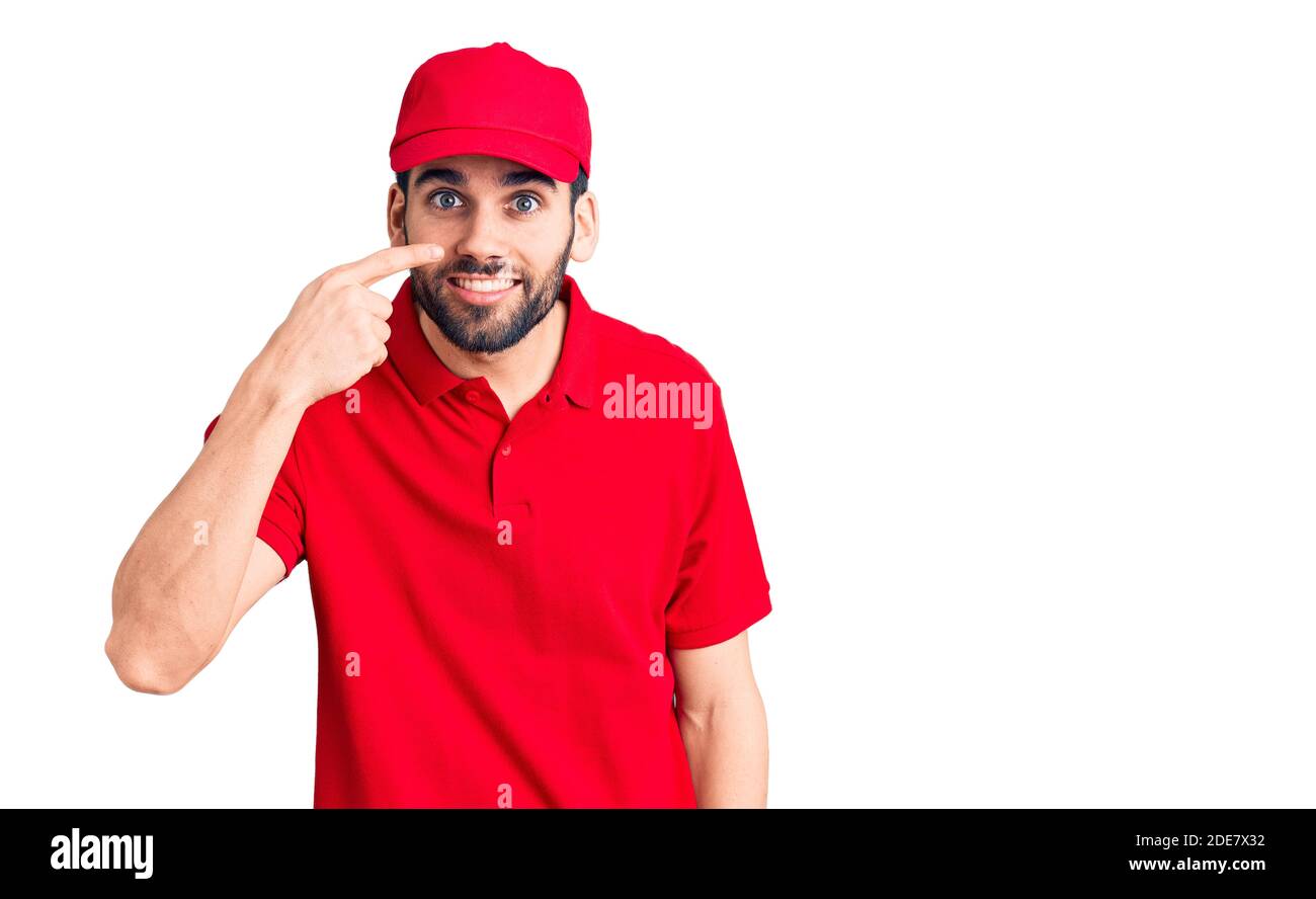 Young Handsome Man With Beard Wearing Delivery Uniform Pointing With