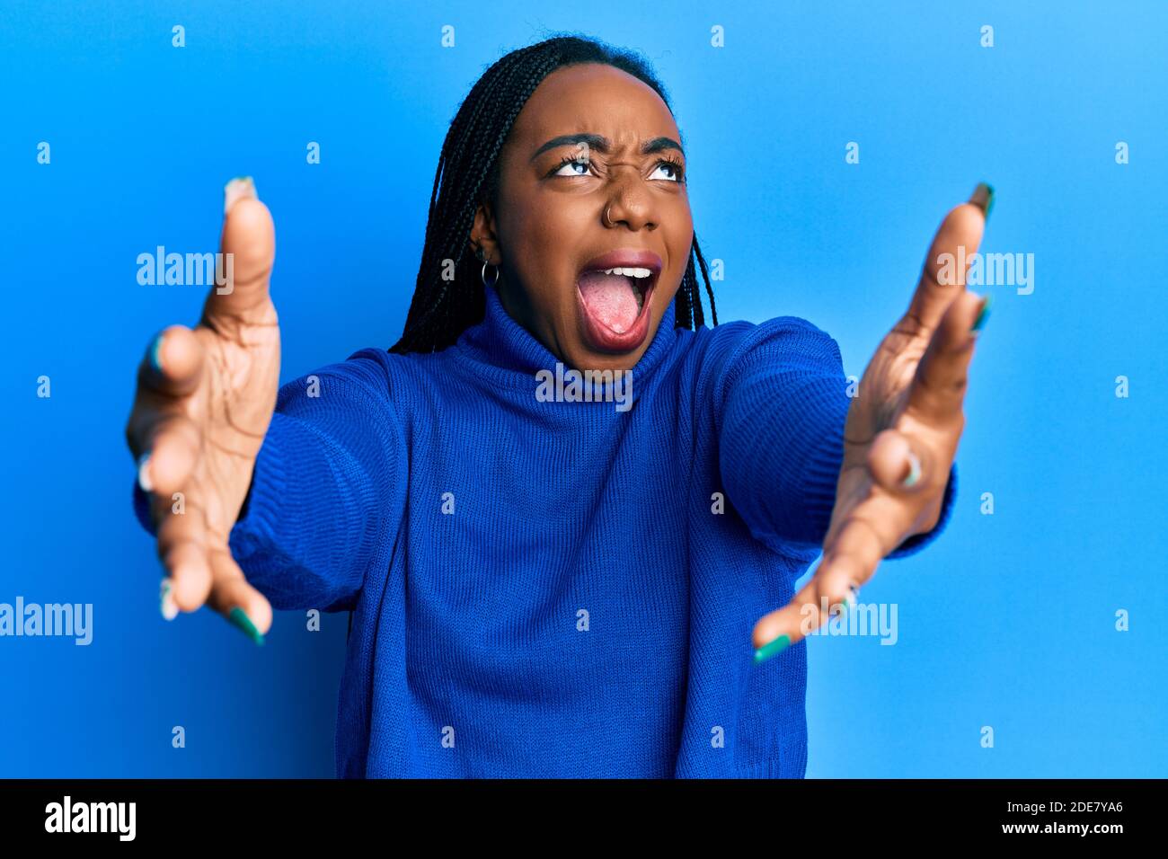 Young african american woman with arms stretched hug gesture angry and ...