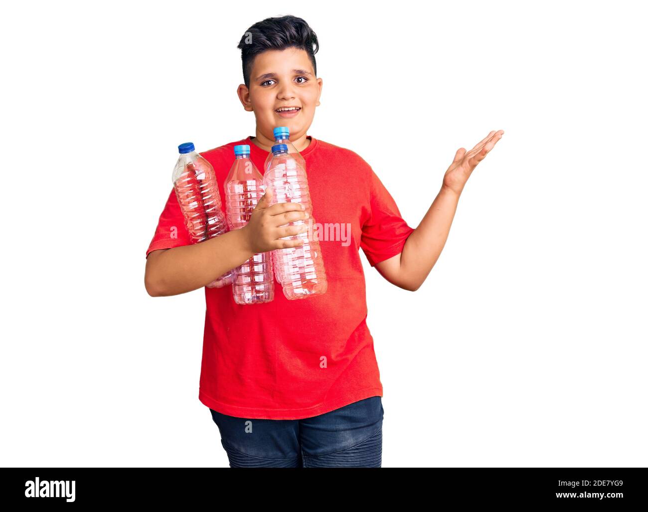 Little boy kid holding recycling plastic bottles celebrating victory ...