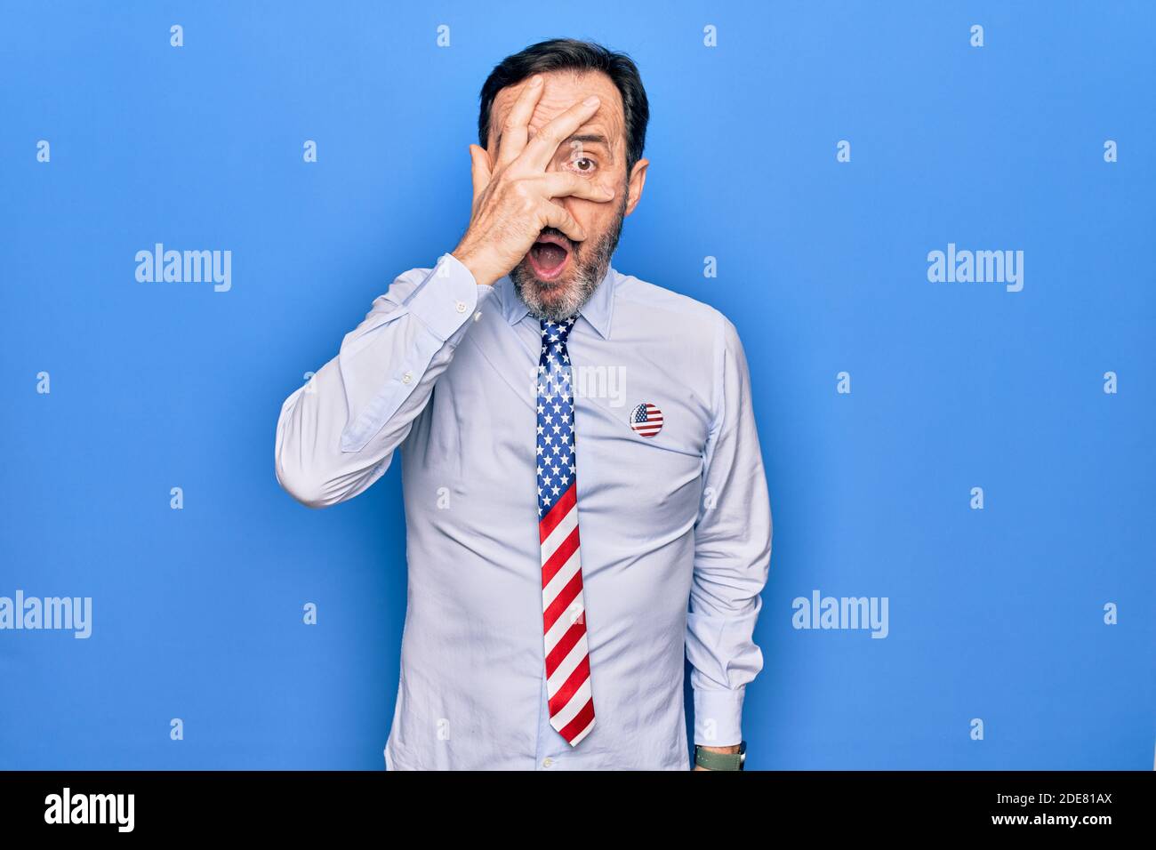 Middle age handsome patriotic businessman wearing united states tie ...