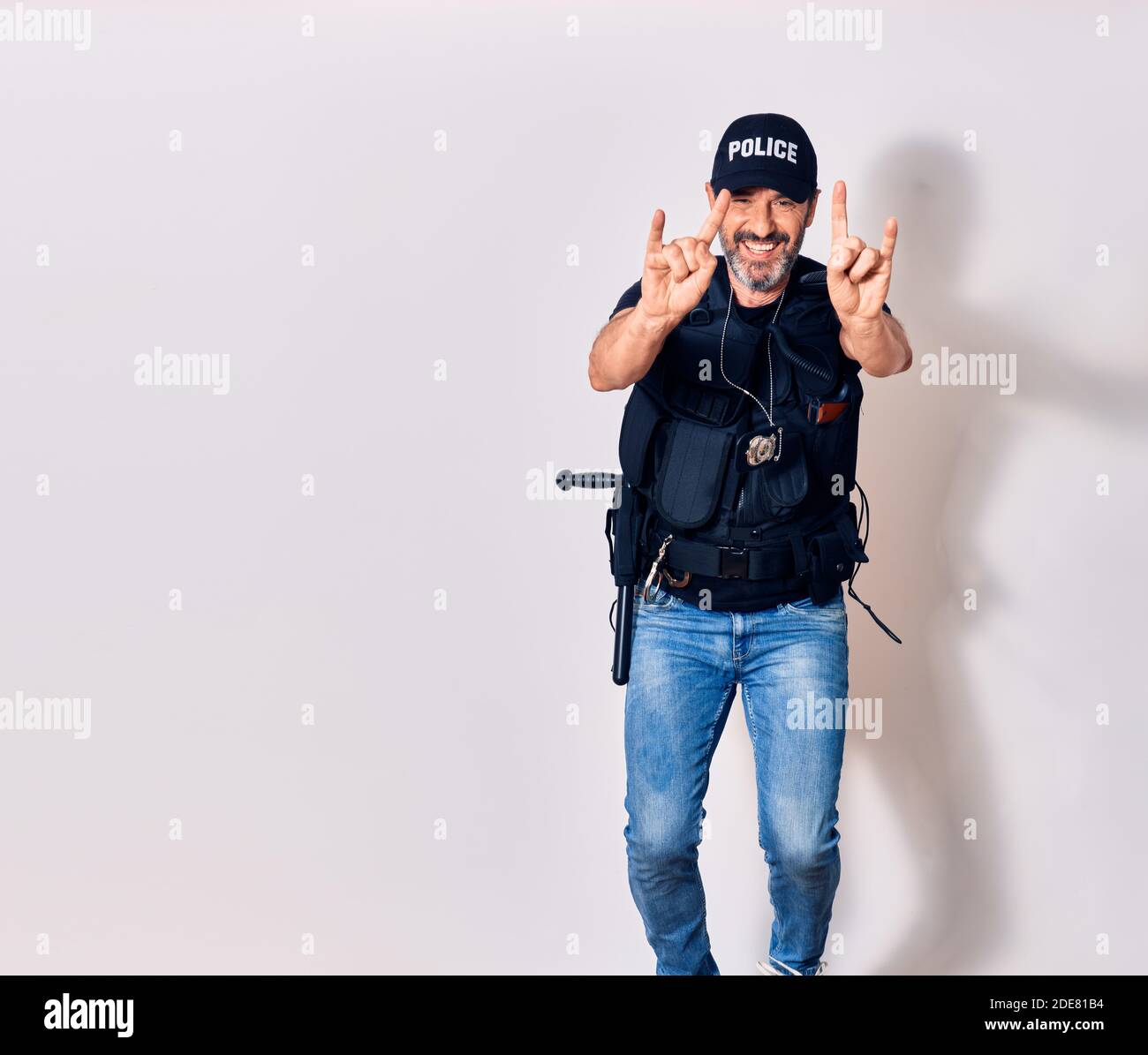 Middle age handsome man wearing police unifrom smiling happy. Jumping ...