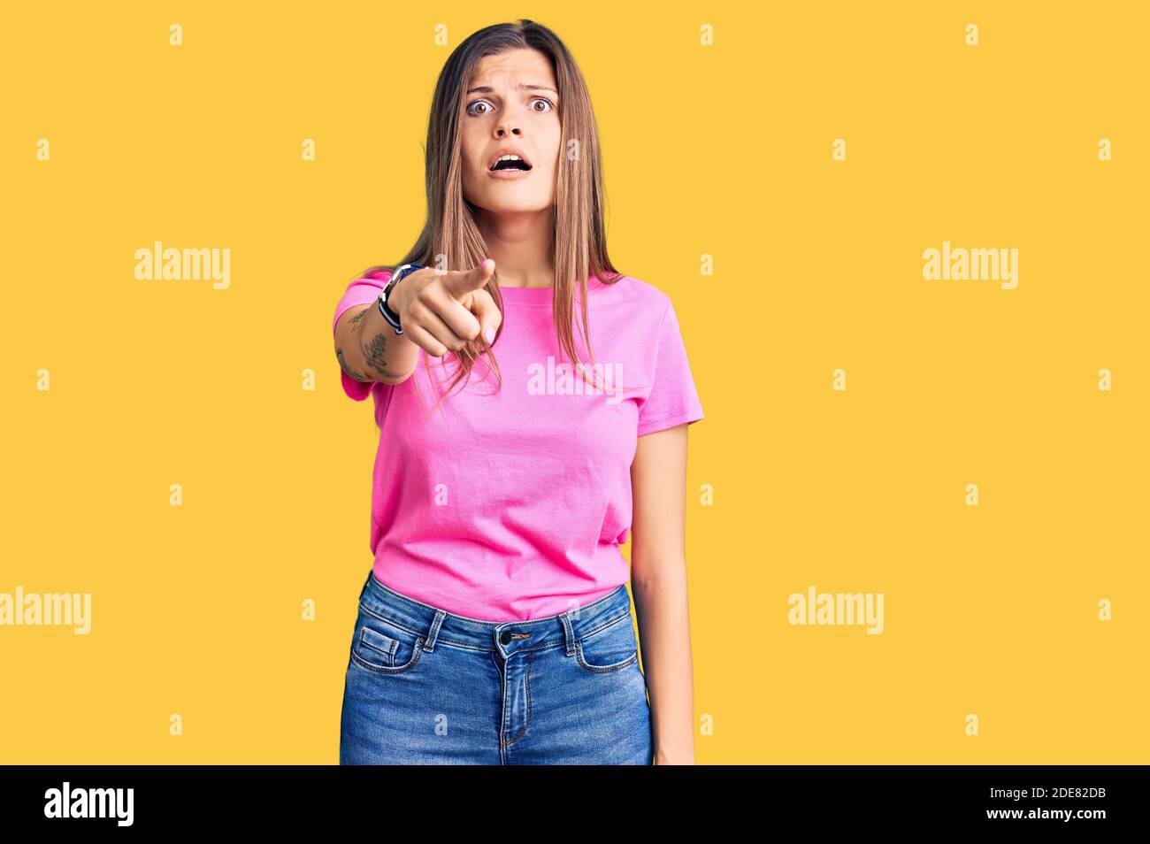 Beautiful caucasian woman wearing casual clothes pointing displeased ...