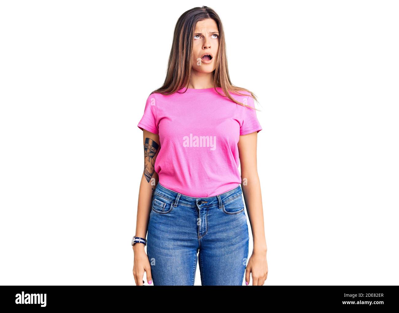 Beautiful caucasian woman wearing casual clothes in shock face, looking ...